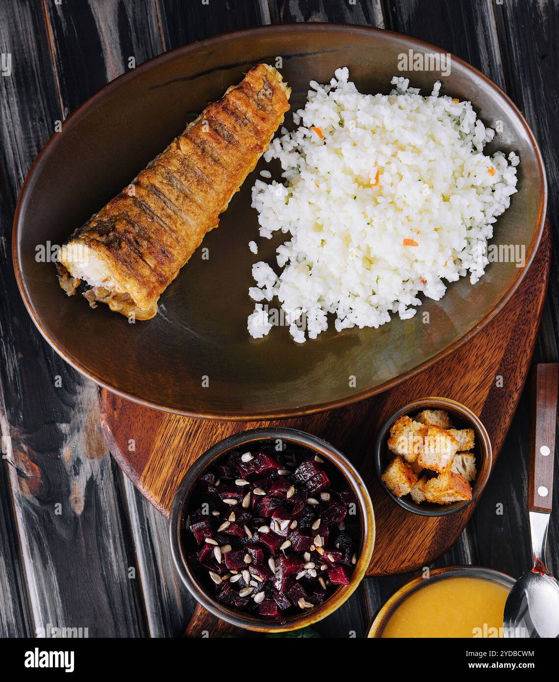 Roast fish with white rice on a cutting board Stock Photo - Alamy