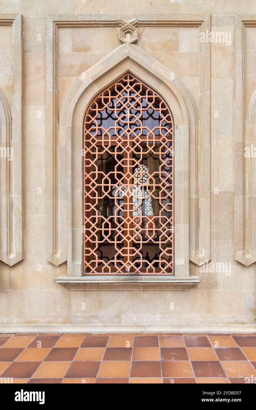 This historic building features an ornate window with intricate lattice ...