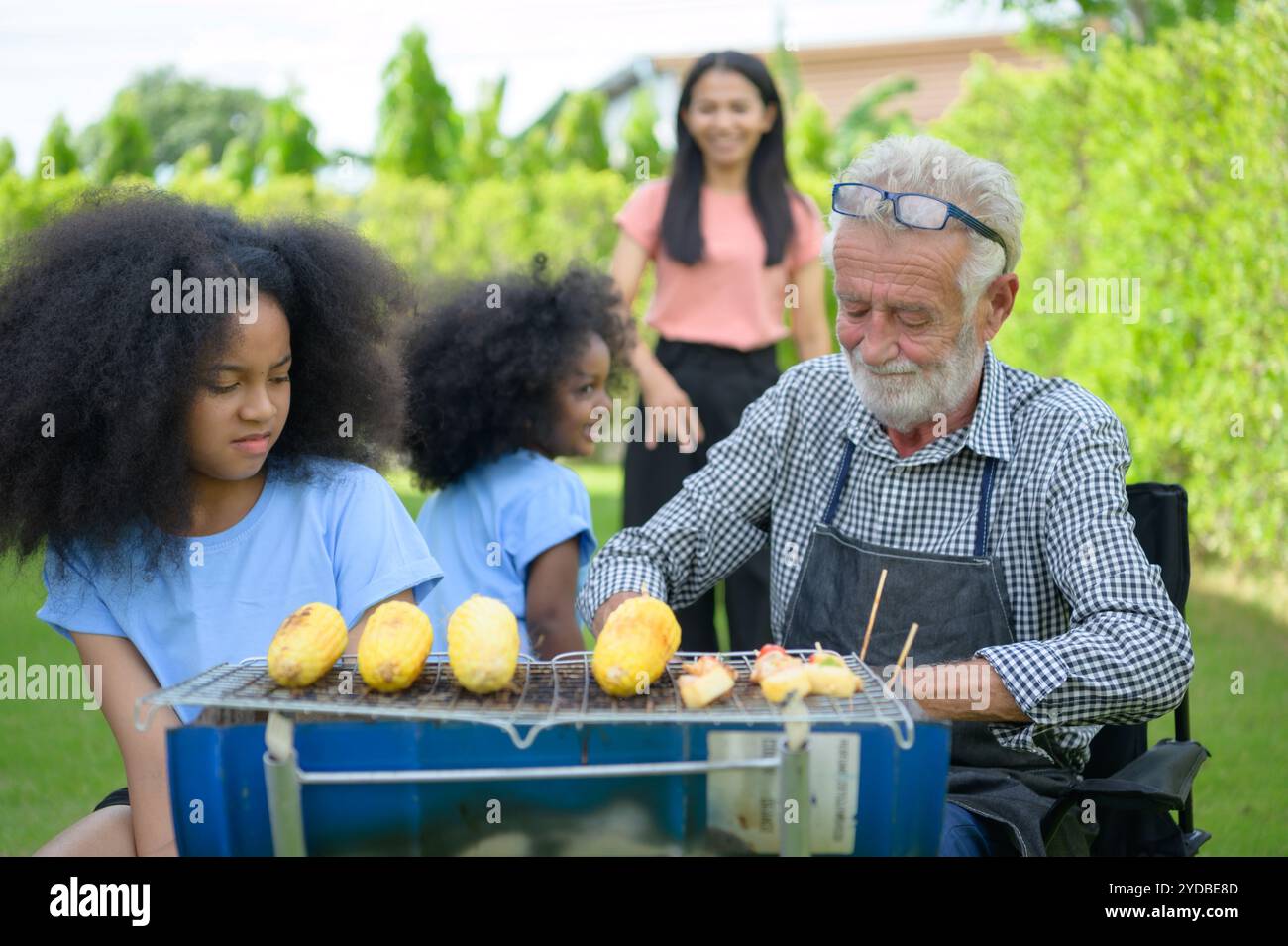 Family holiday activities with grandfather, mother and children with ...