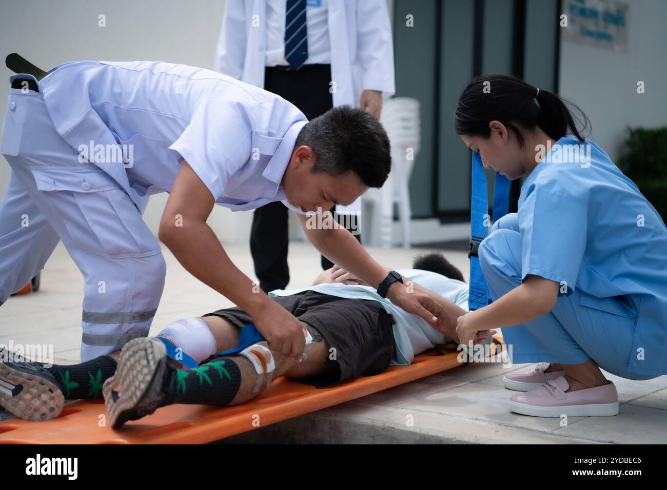 First aid assistance of the ambulance medical team with CPR method and hand-squeezed breathing ...