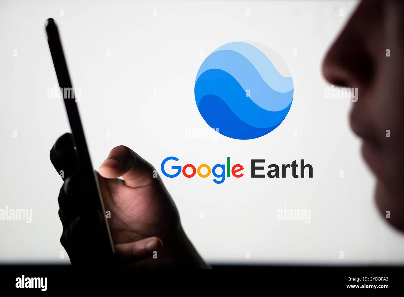 Dhaka, Bangladesh- 23 July 2024: Google Earth logo is seen displayed behind a woman holding a ...