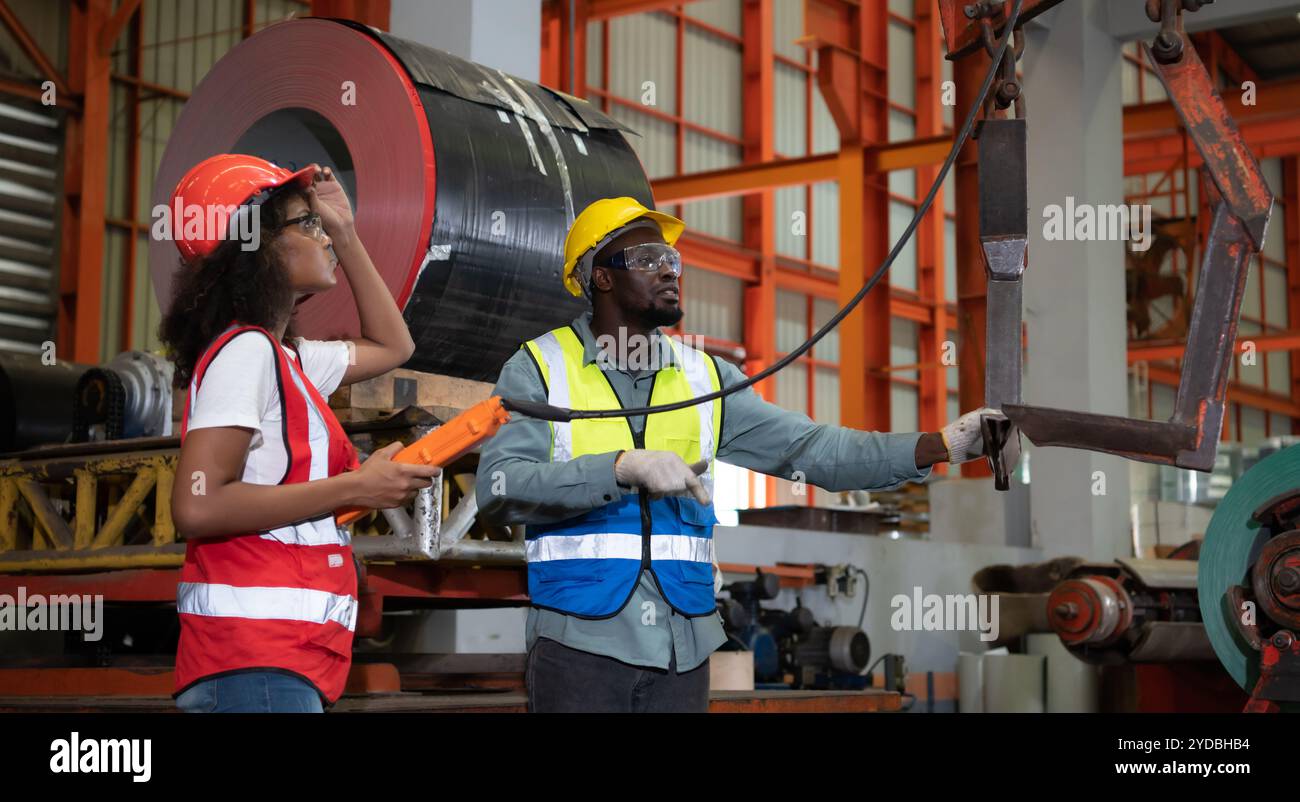 Two technicians Inspecting and testing the operation of lifting cranes ...