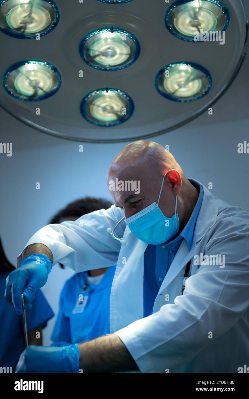 A medical professor is teaching surgery to medical students working ...