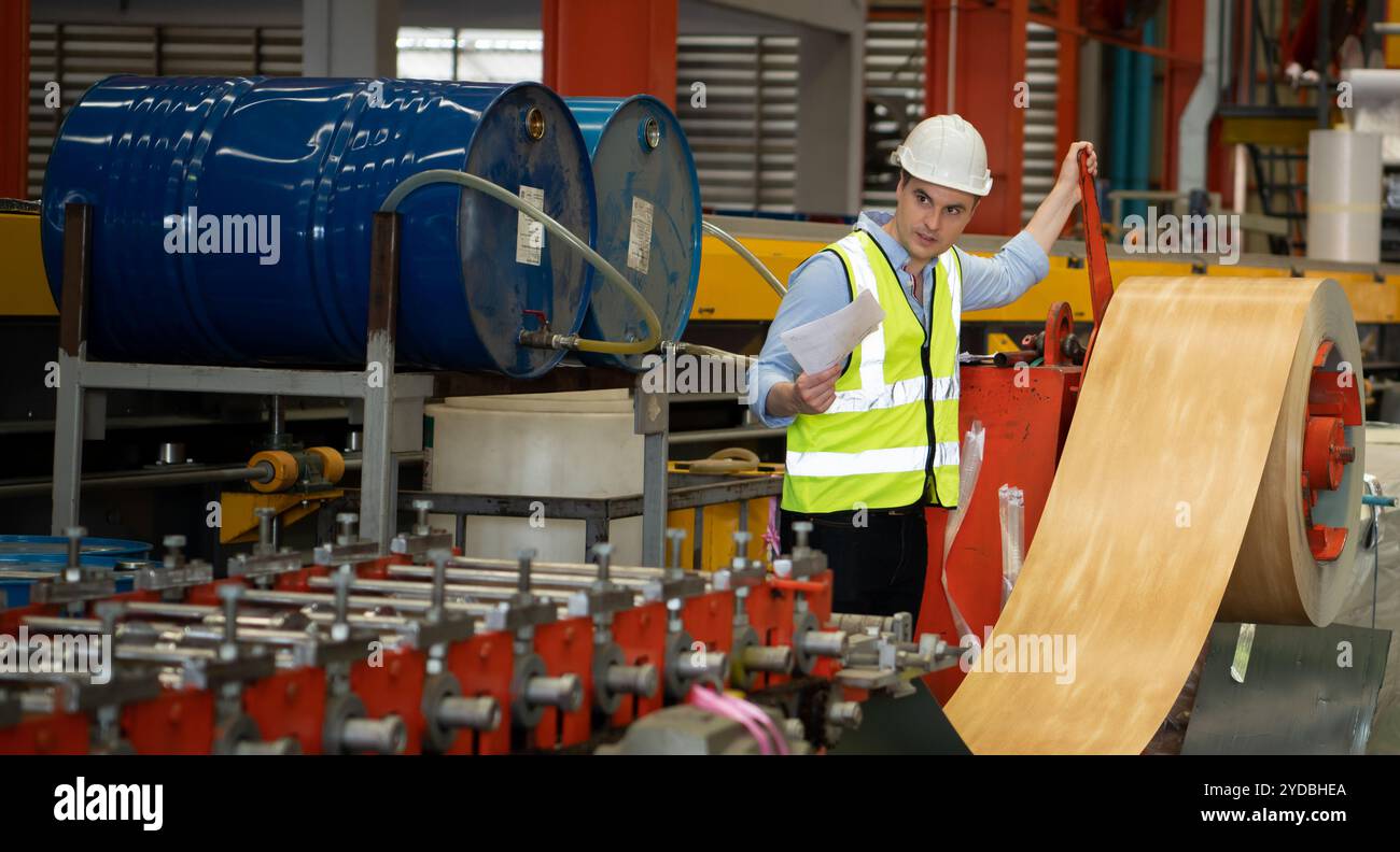 Two young engineers Testing and verifying the operation of the machines ...