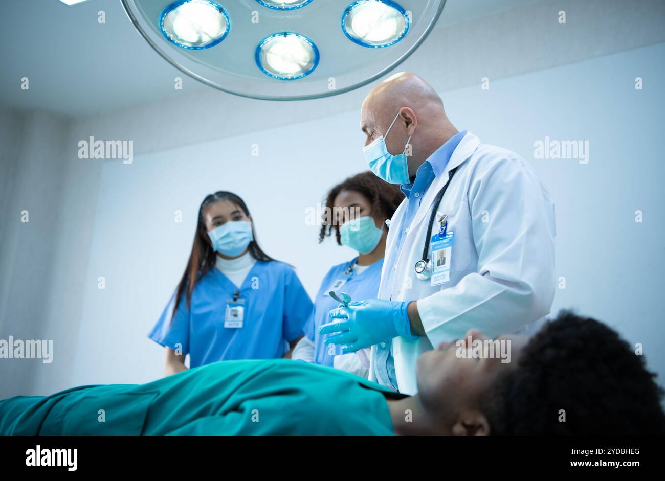A medical professor is teaching surgery to medical students working ...