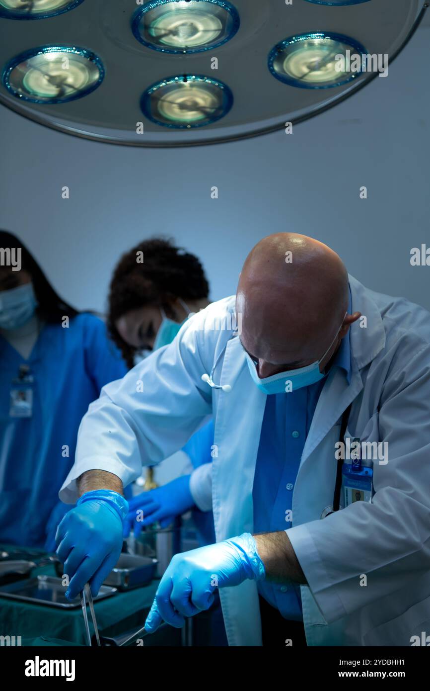 A medical professor is teaching surgery to medical students working ...