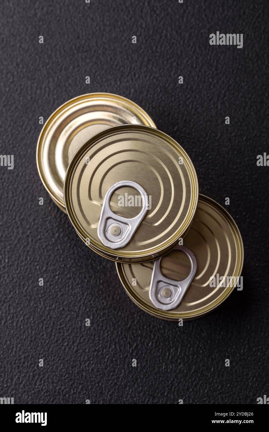 Round metal can with canned meat or fish with a key to open it on a ...