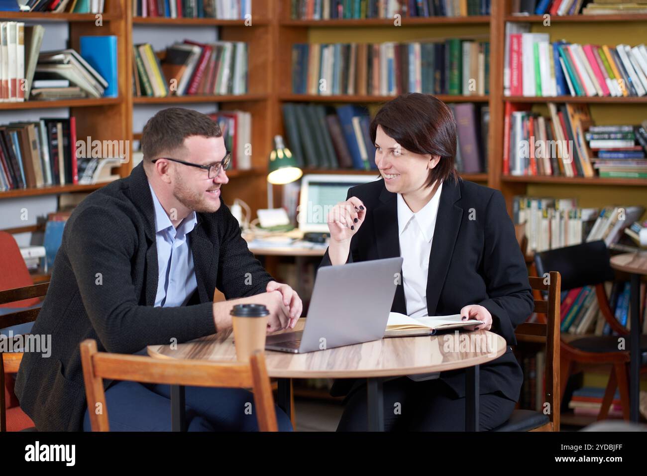 Man sitting desk laptop talking hi-res stock photography and images - Alamy