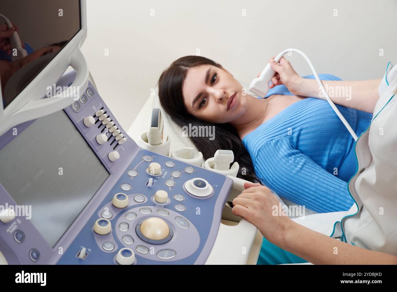 Doctor using ultrasound scanning machine examining female neck Stock ...