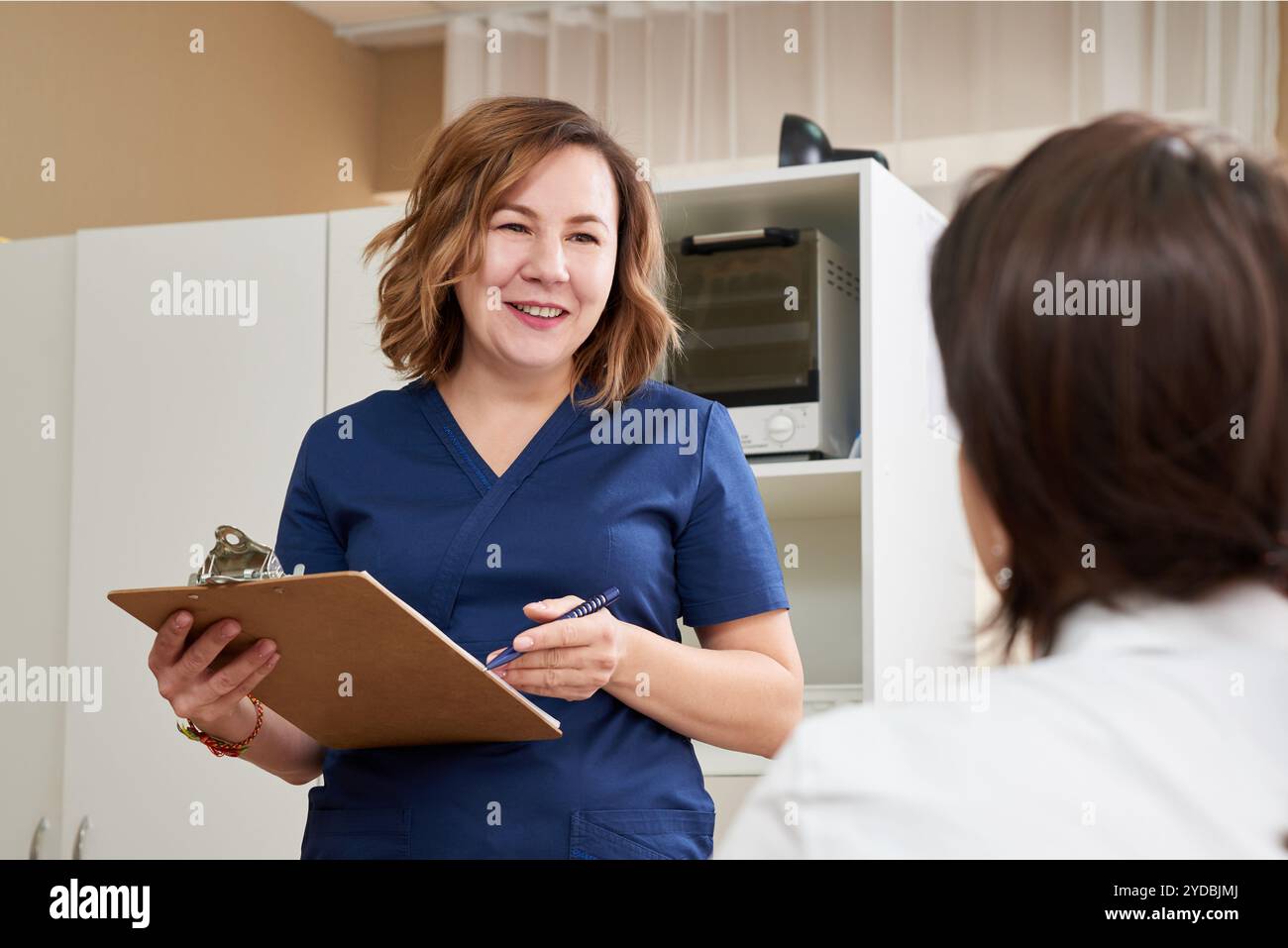 Young female doctor patient talking hi-res stock photography and images ...