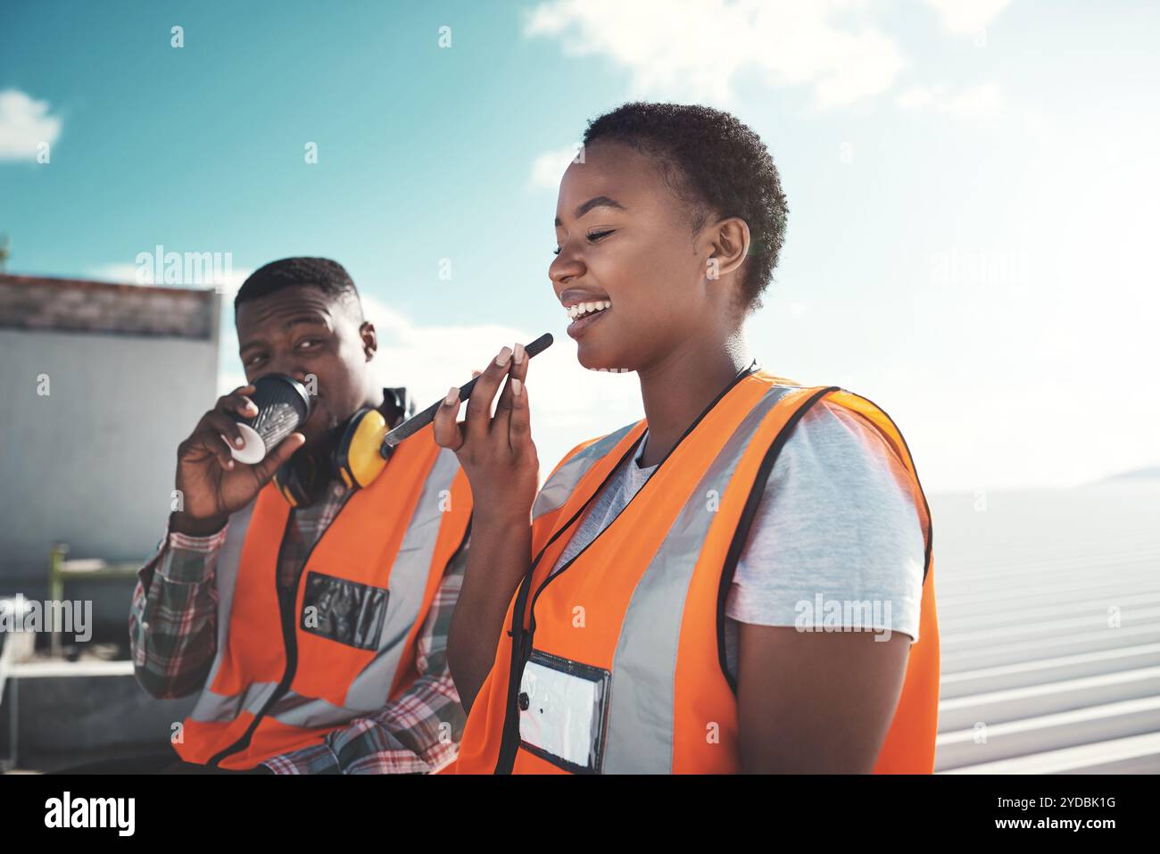 Black woman, phone speaker and talking at construction site, outdoor ...