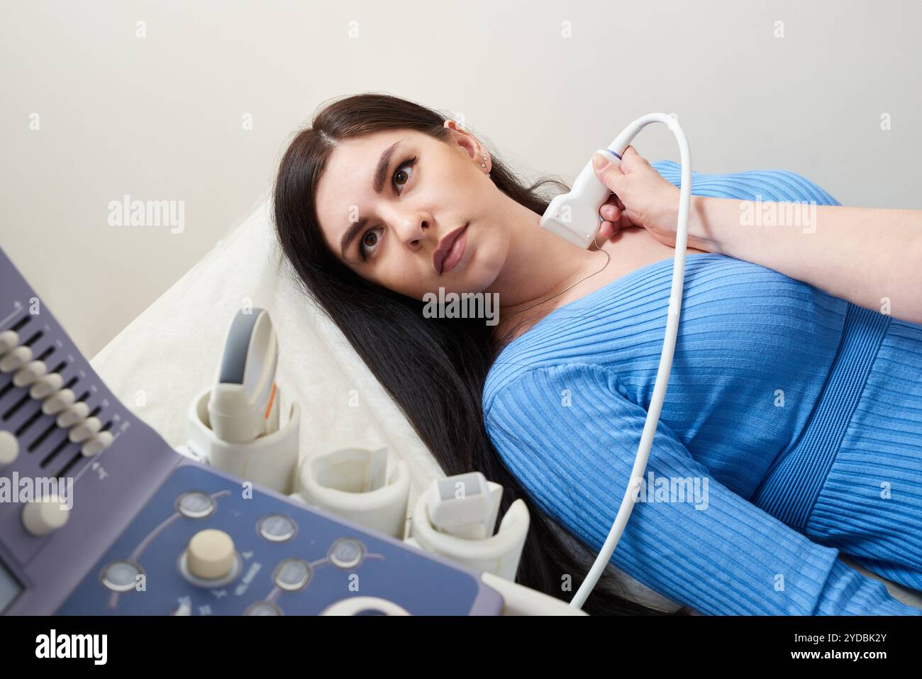 Doctor using ultrasound scanning machine examining female neck Stock ...