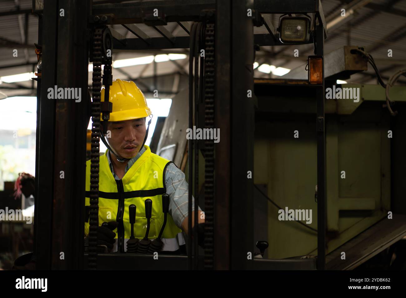 Asian mechanic working in a mechanical factory Repairing old machines ...