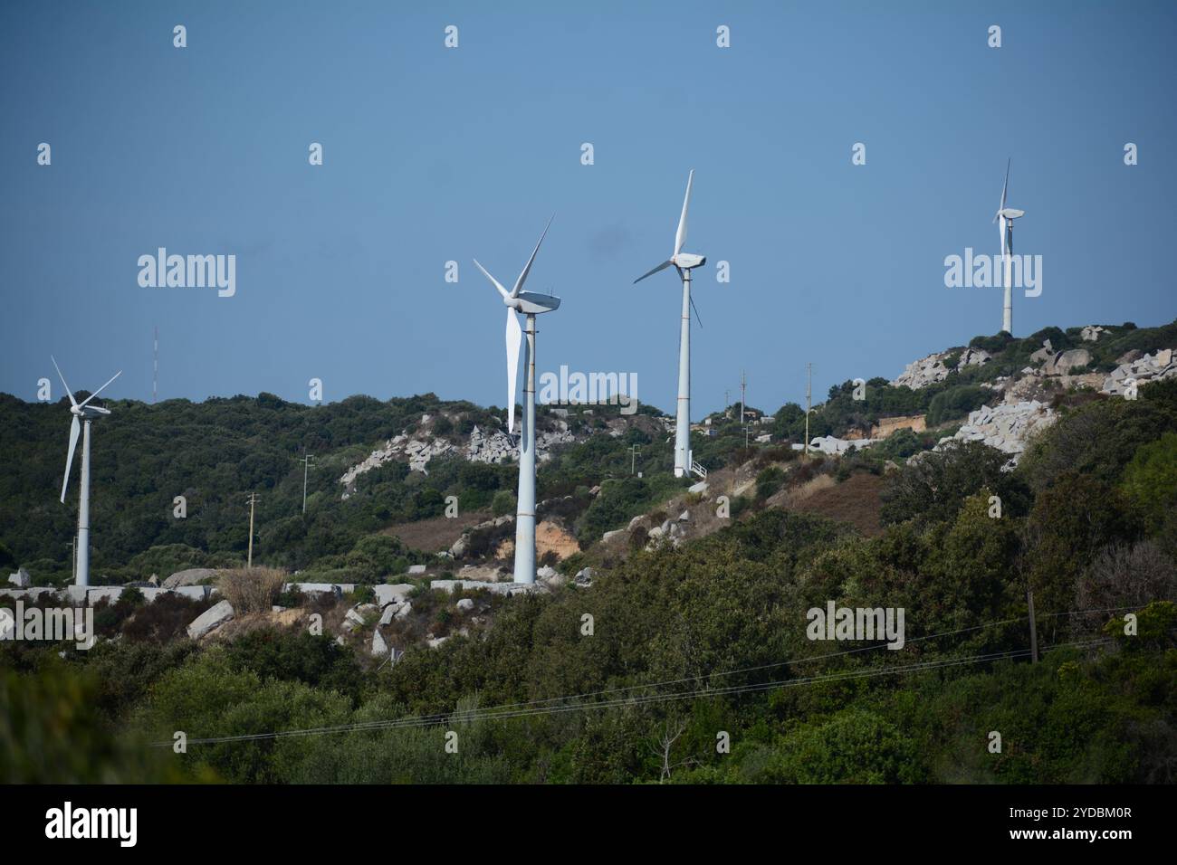 Wind turbines against the blue Sardinian sky, harnessing Mediterranean ...