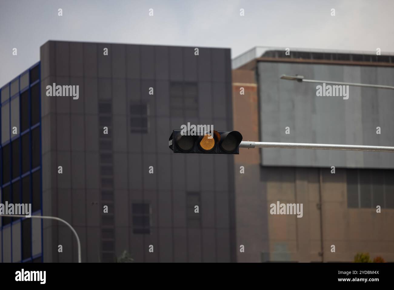 The yellow traffic light flickered, signaling to prepare for the ...