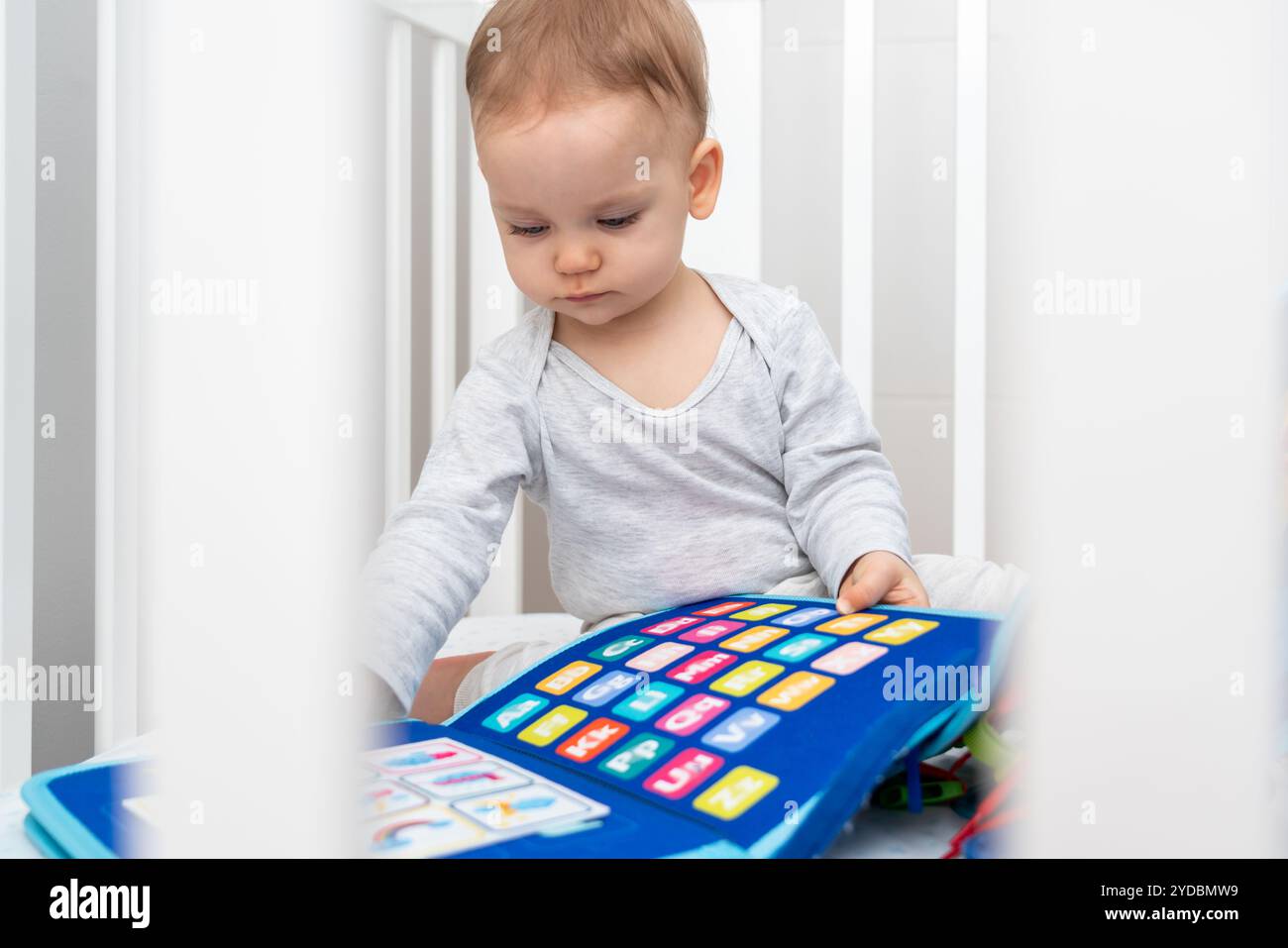 Baby playing busy book hi-res stock photography and images - Alamy