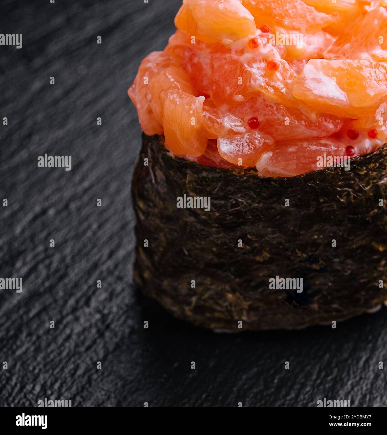 Gunkan with salmon on black wood background Stock Photo - Alamy