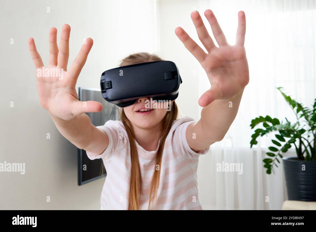 Teenage girl wearing virtual reality goggles headset and playing, vr ...