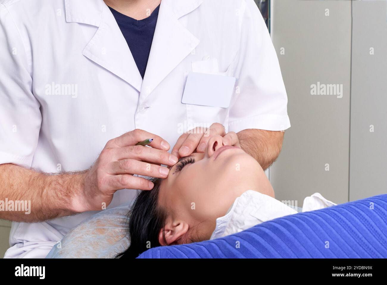 Plastic surgeon and young woman with correction lines before cosmetic ...