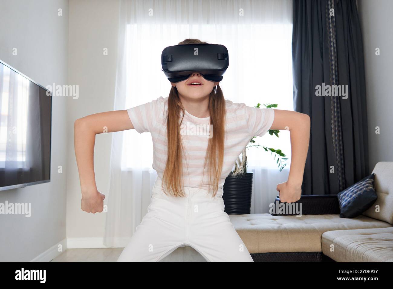 Teenage girl wearing virtual reality goggles headset and playing, vr ...