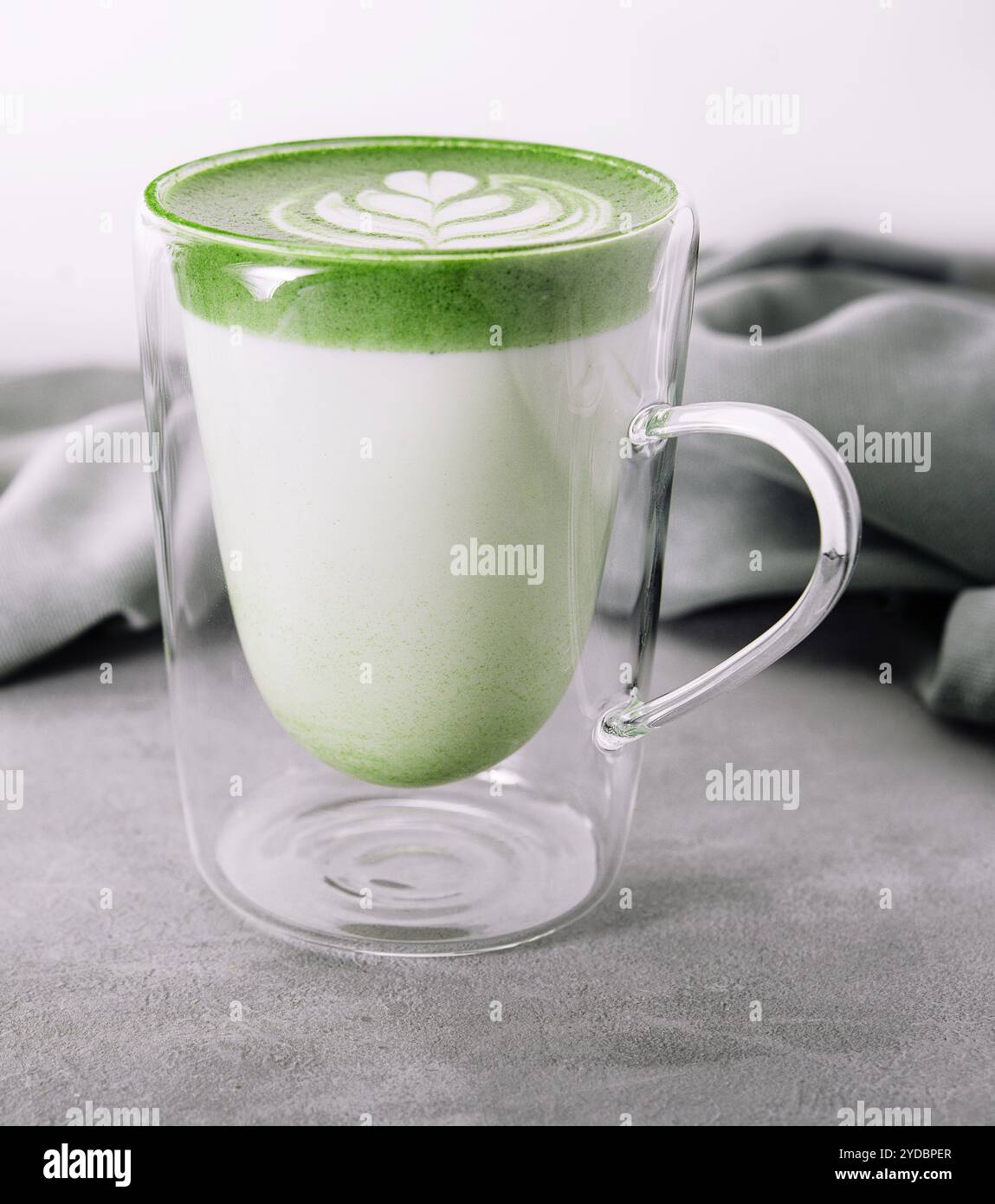 Glass of hot matcha green tea latte with tulip pattern Stock Photo - Alamy