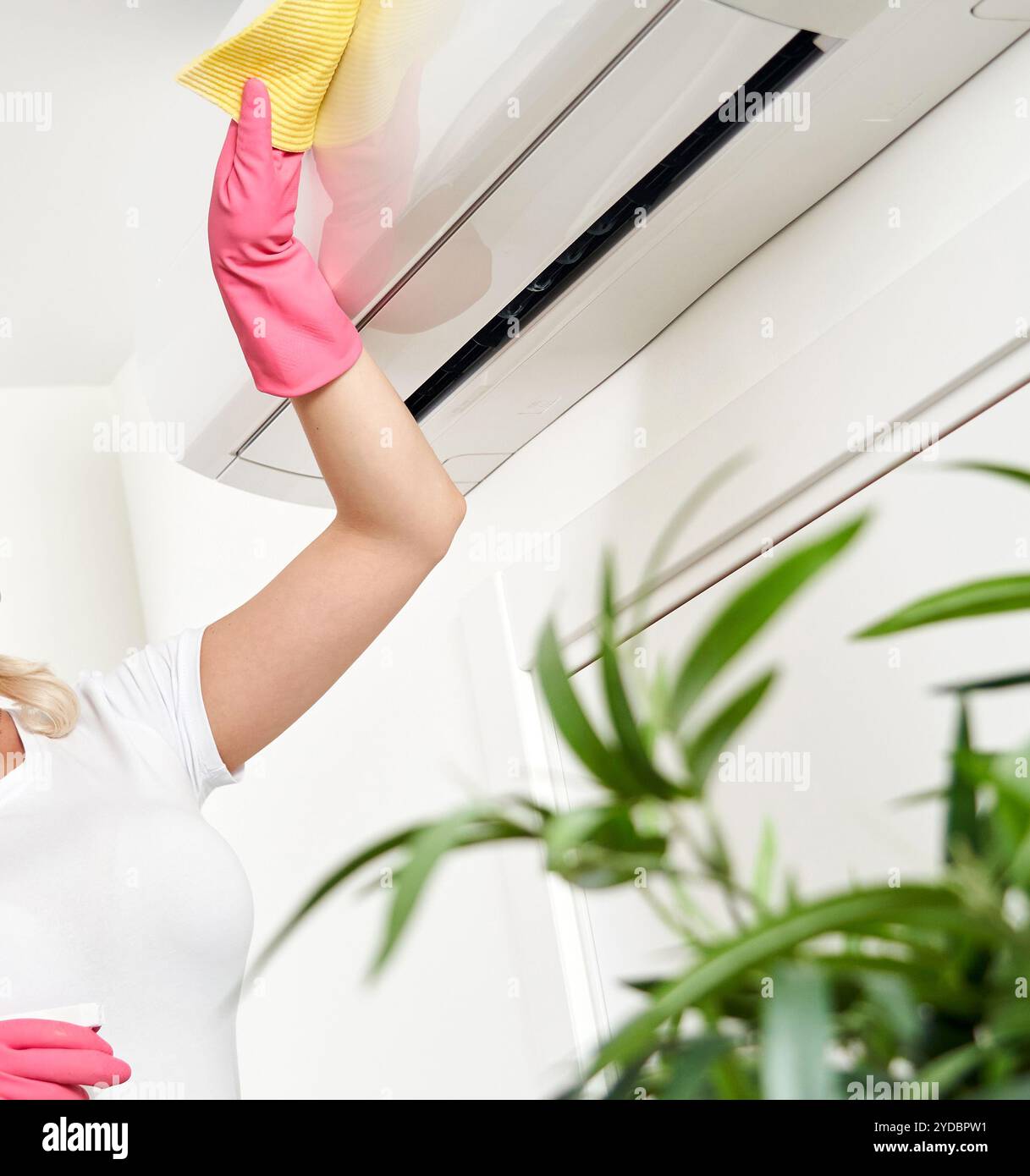 Woman cleaning air conditioner with rag. Cleaning service concept Stock ...