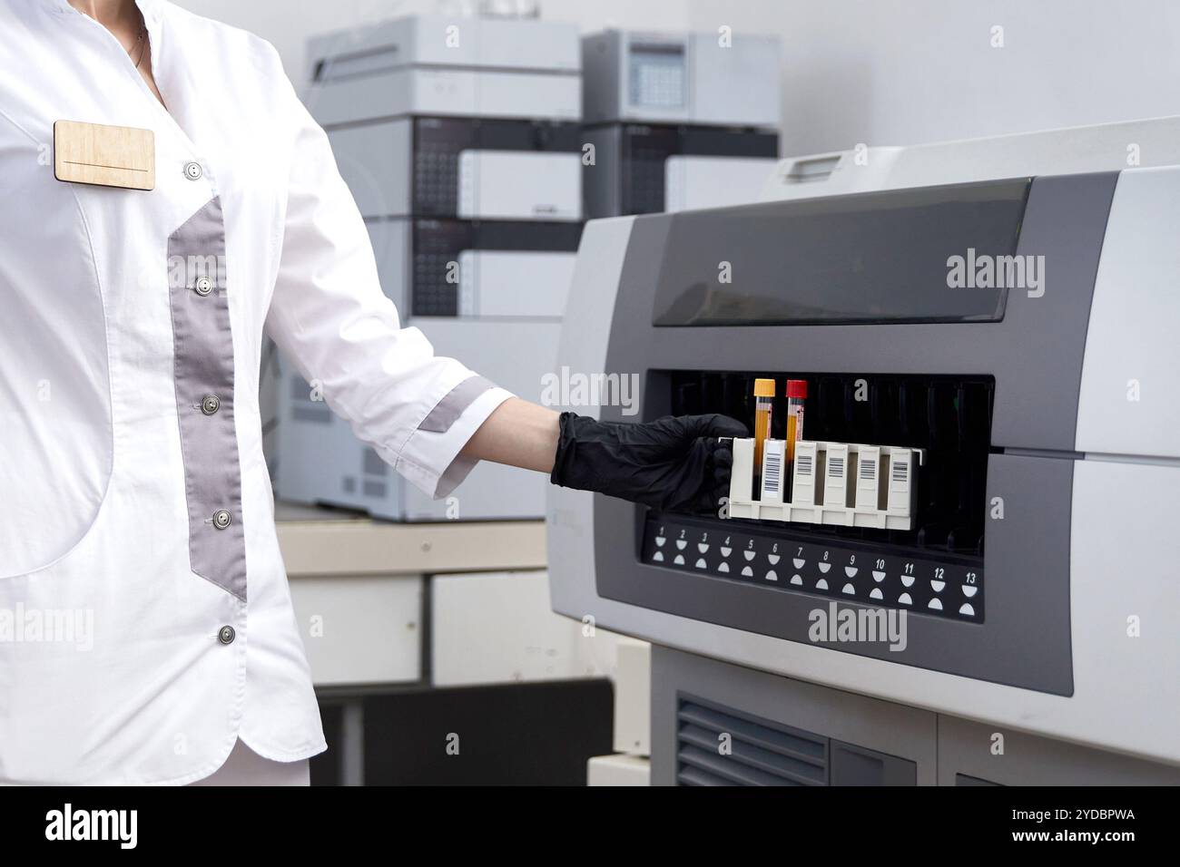 Female Research Scientist Putting Test Tube with Blood Sample into ...