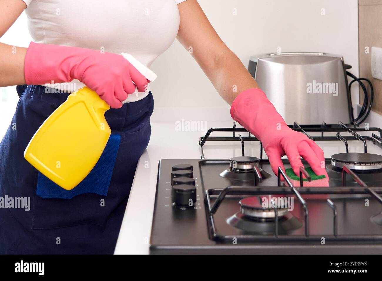 Cleaning a gas stove with kitchen utensils, household concepts, or ...