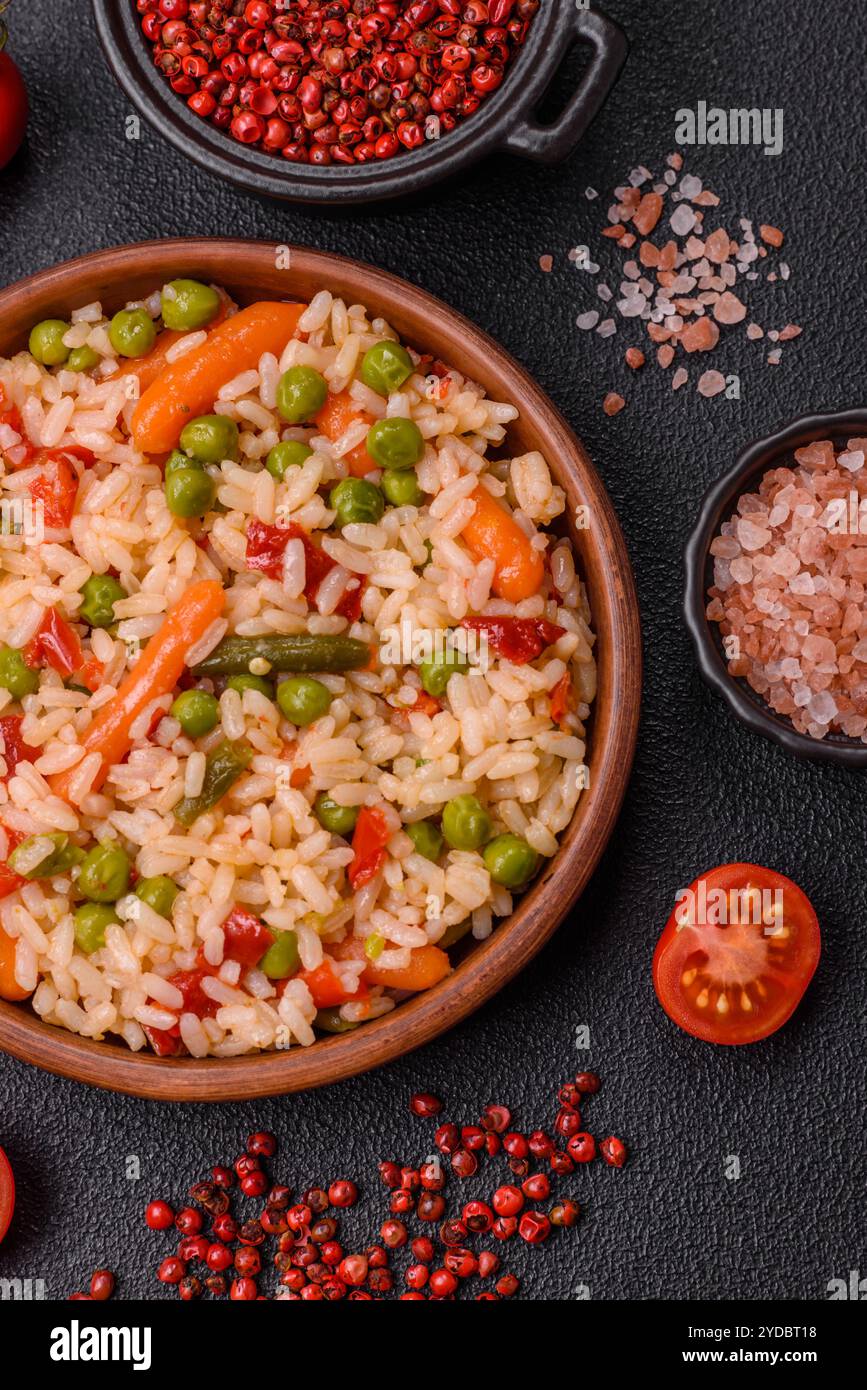 Delicious boiled rice with vegetables carrots, peas and peppers Stock ...
