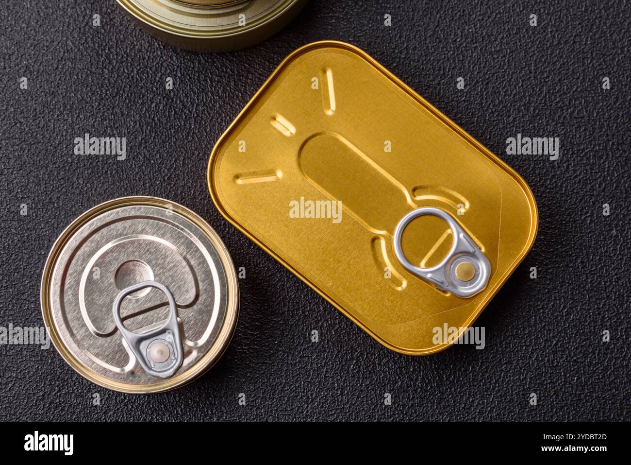 Metal can with canned meat or fish with a key to open it on a dark ...