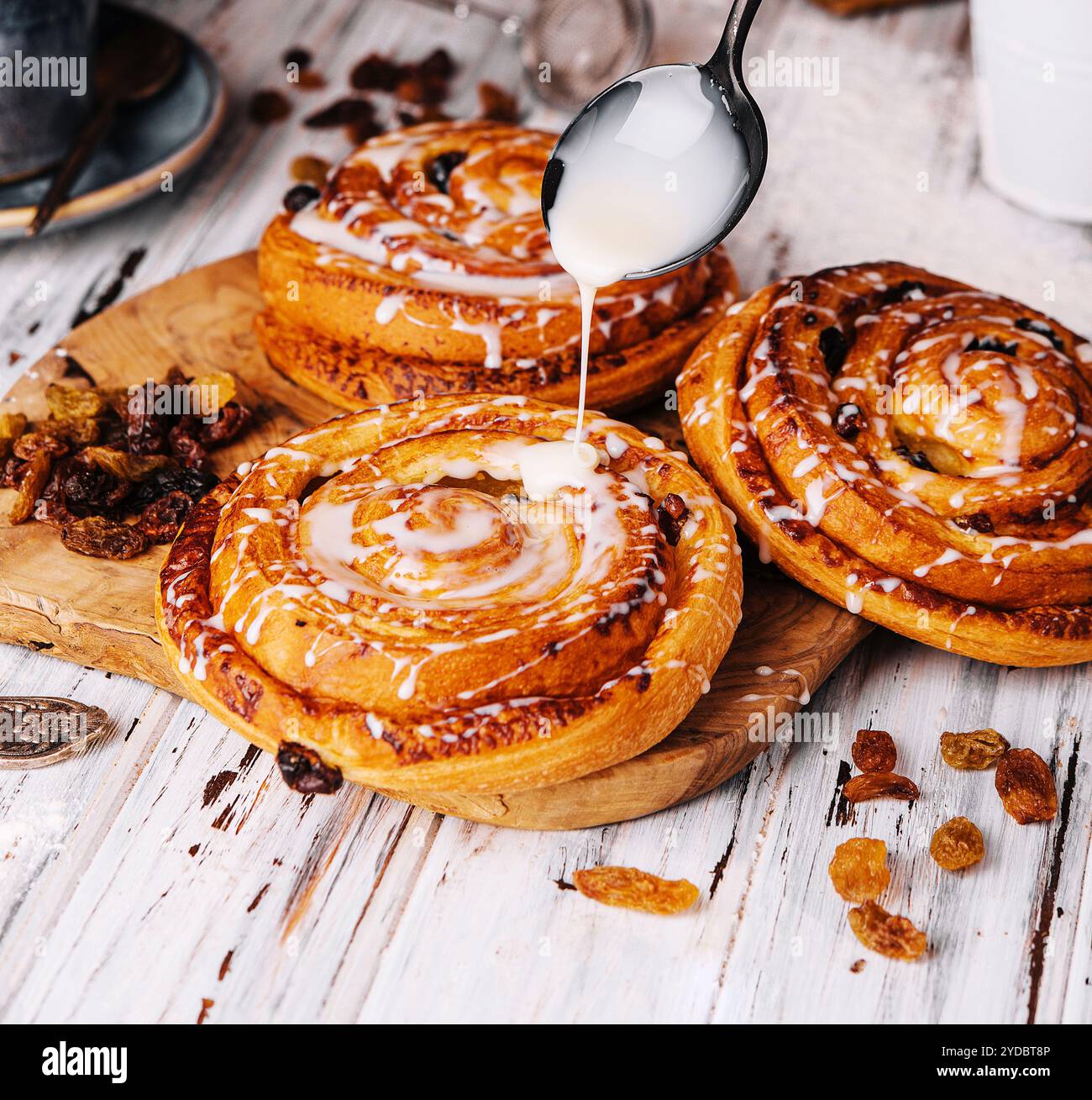 Homemade raisin roll pastry with vanilla icing Stock Photo - Alamy