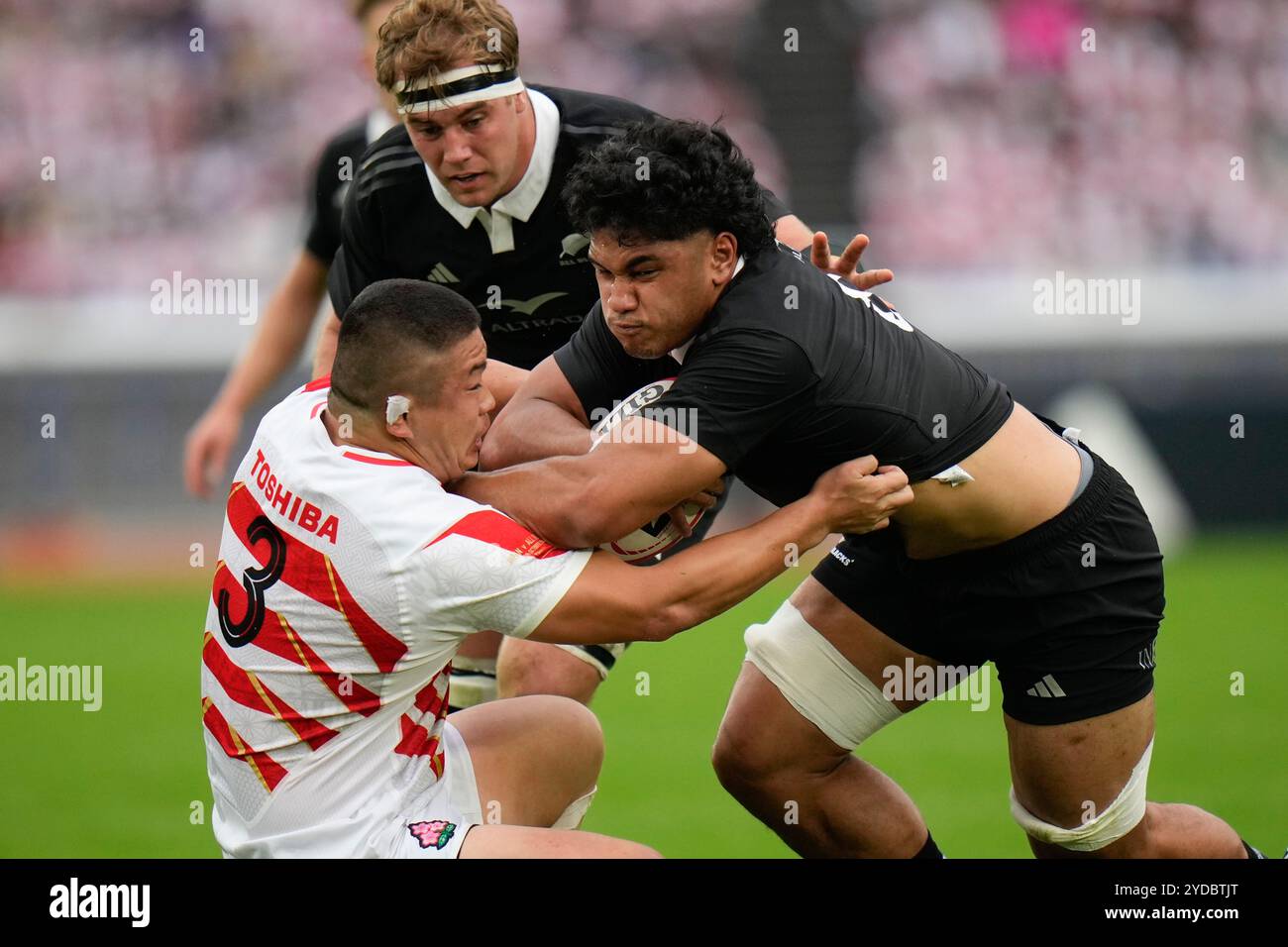 New Zealand's Wallace Sititi, right, runs at Japan's Shuhei Takeuchi ...
