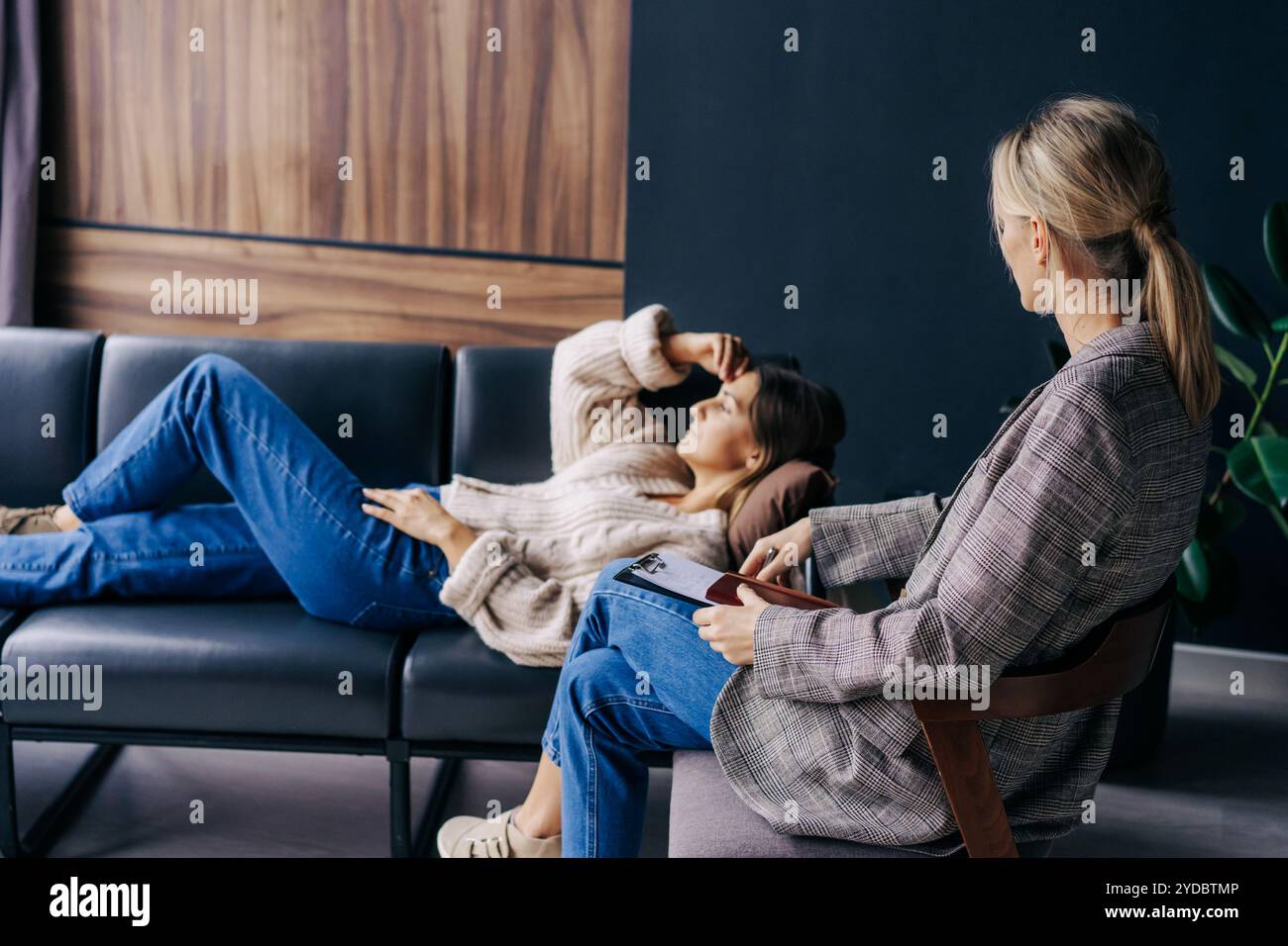 Female therapist listening and consoling a woman talking about problems ...