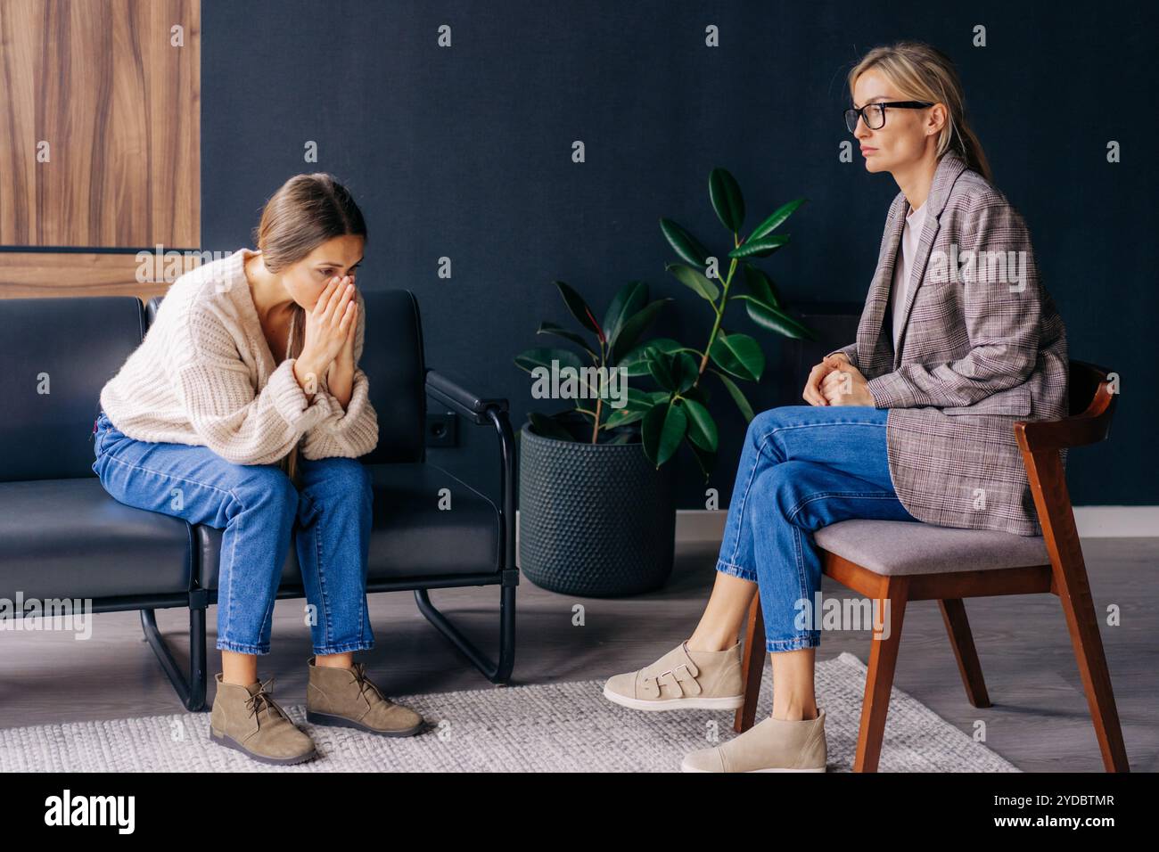 In the office at a session a sad depressed young woman talks about her ...