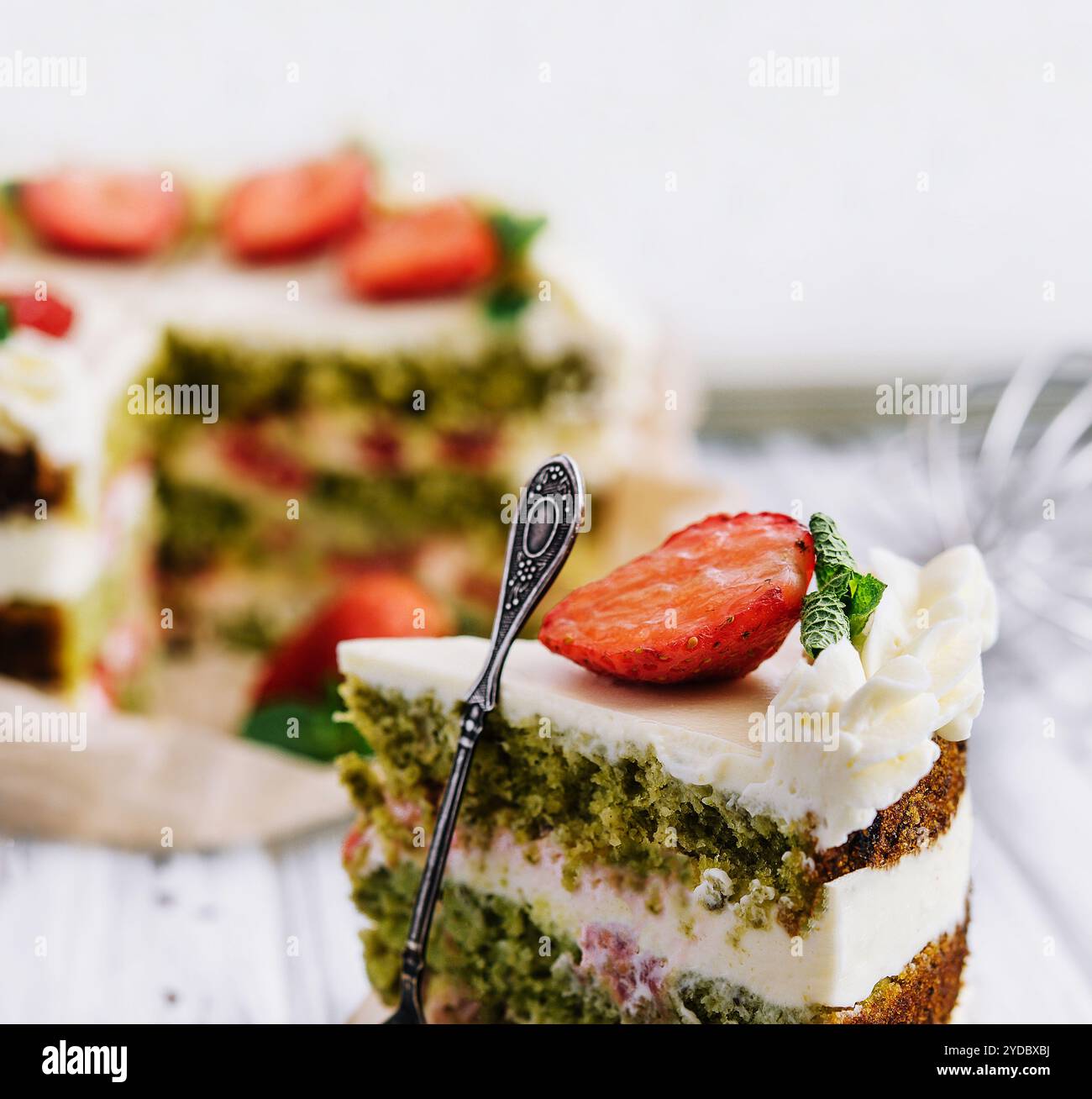 Green pistachio cake with strawberries closeup Stock Photo - Alamy