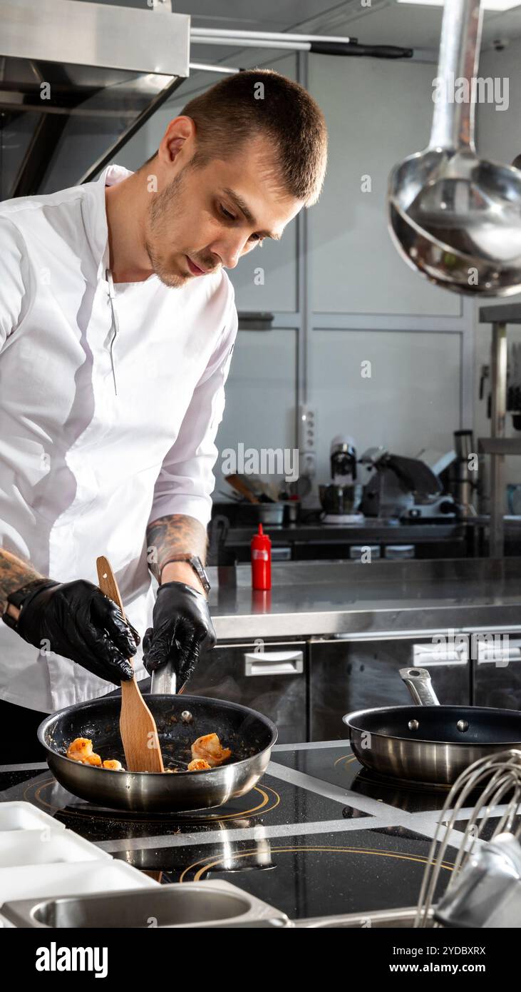 Chef in professional kitchen cooks hi-res stock photography and images ...