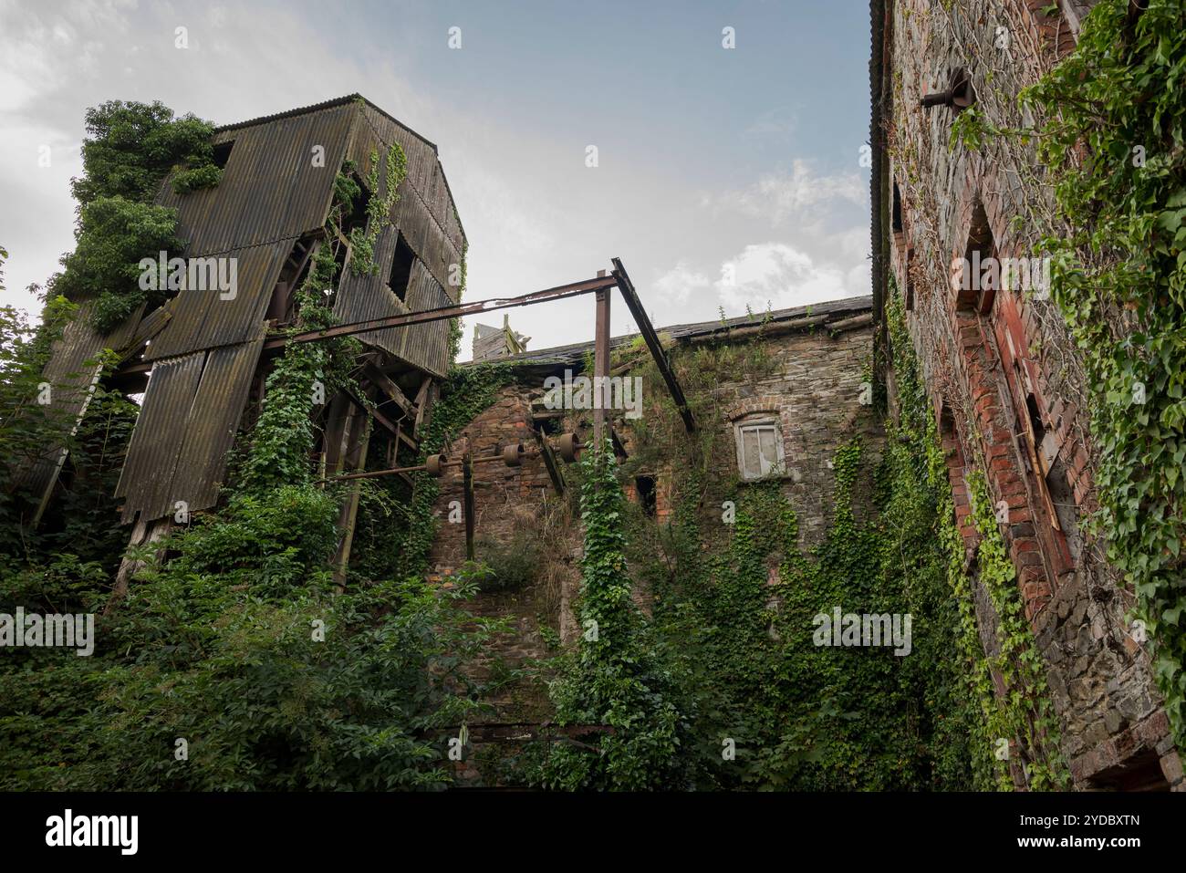 Ruins of an abandoned, industrial building shows crumbling stone and ...