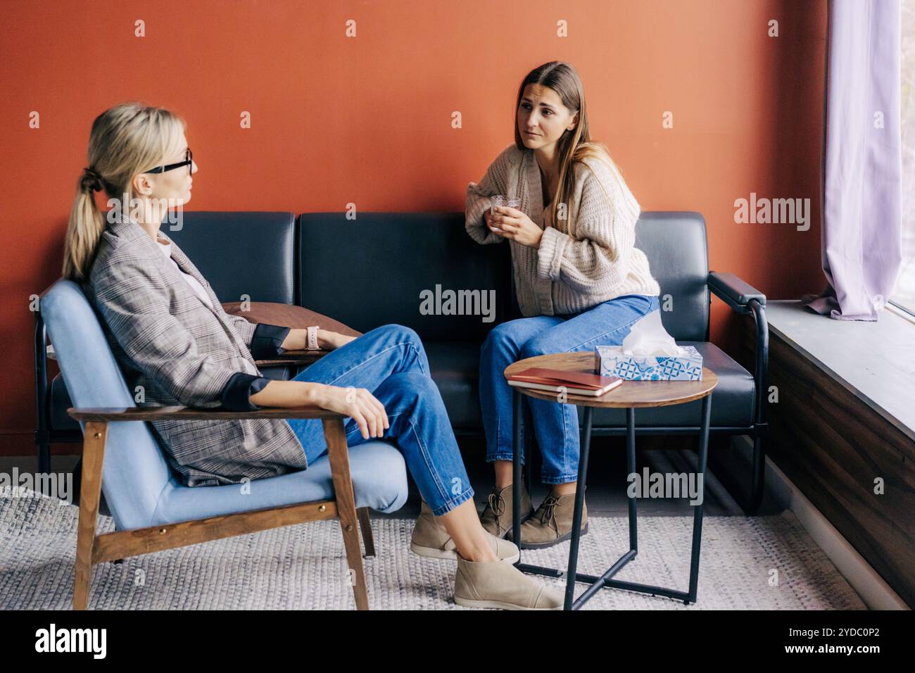 Female psychologist listening to a depressed woman in an appointment ...