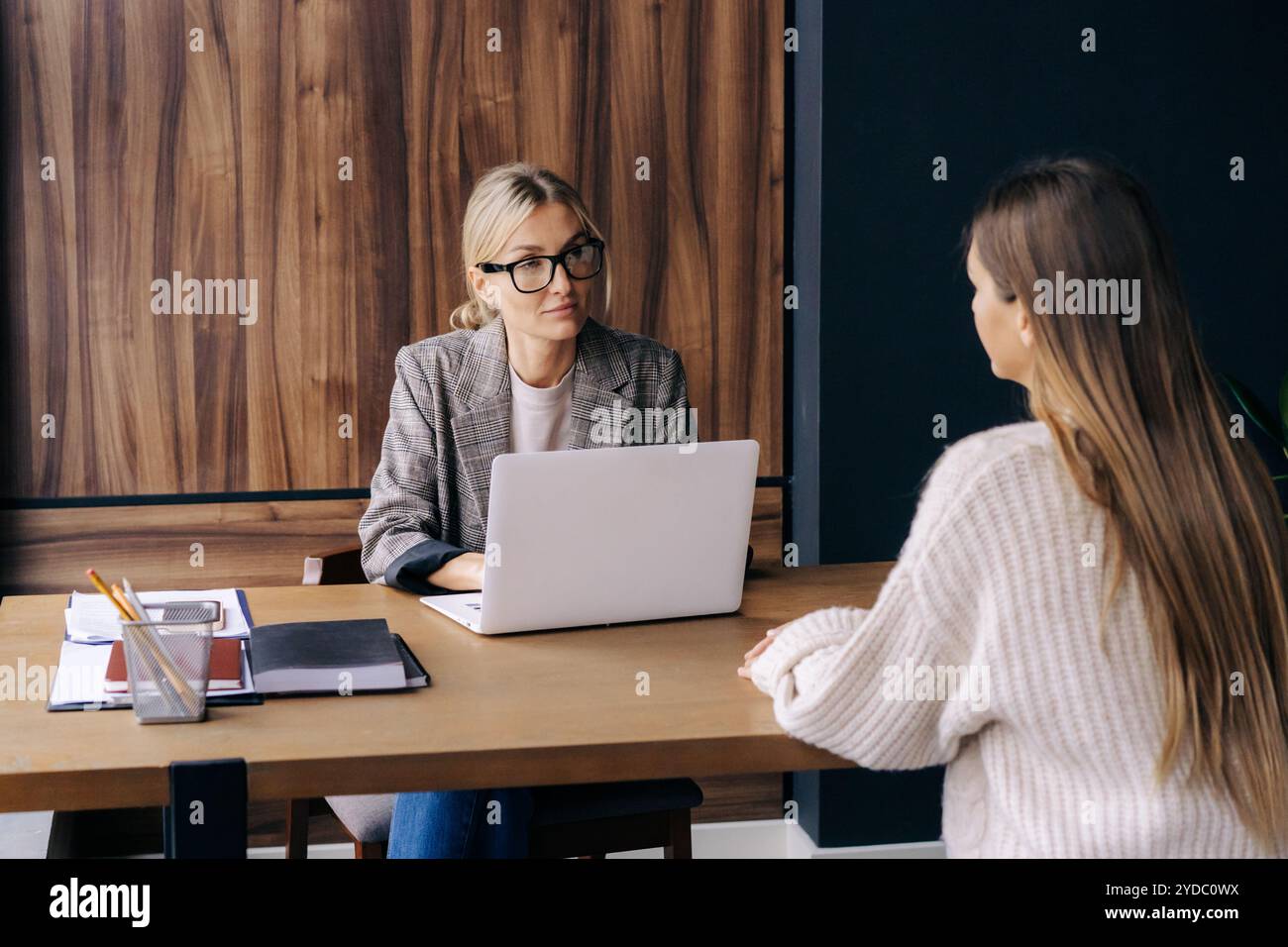 Woman professional HR interviews a candidate for a vacancy while ...