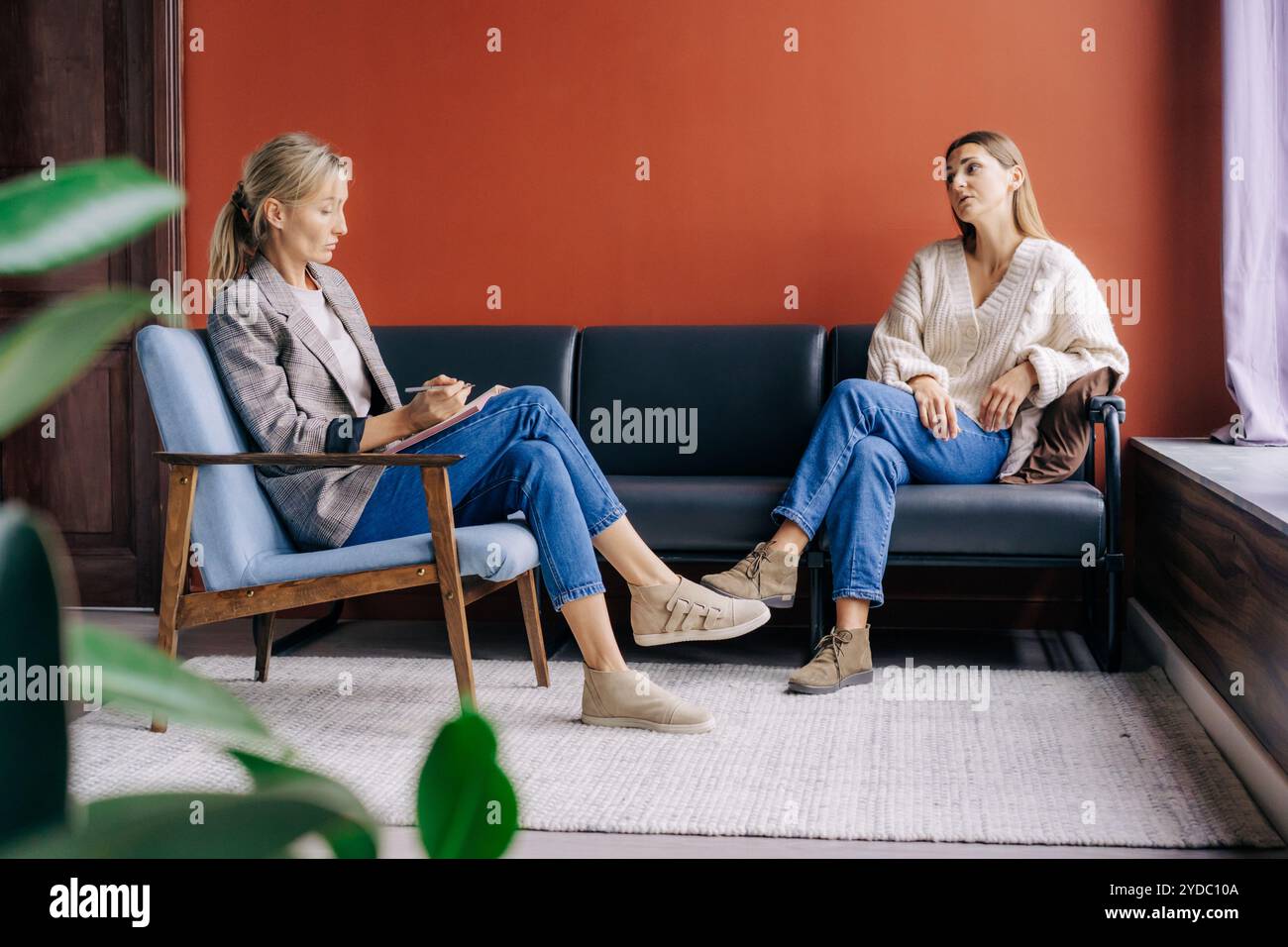 A female psychotherapist during a visit attentively listens and ...