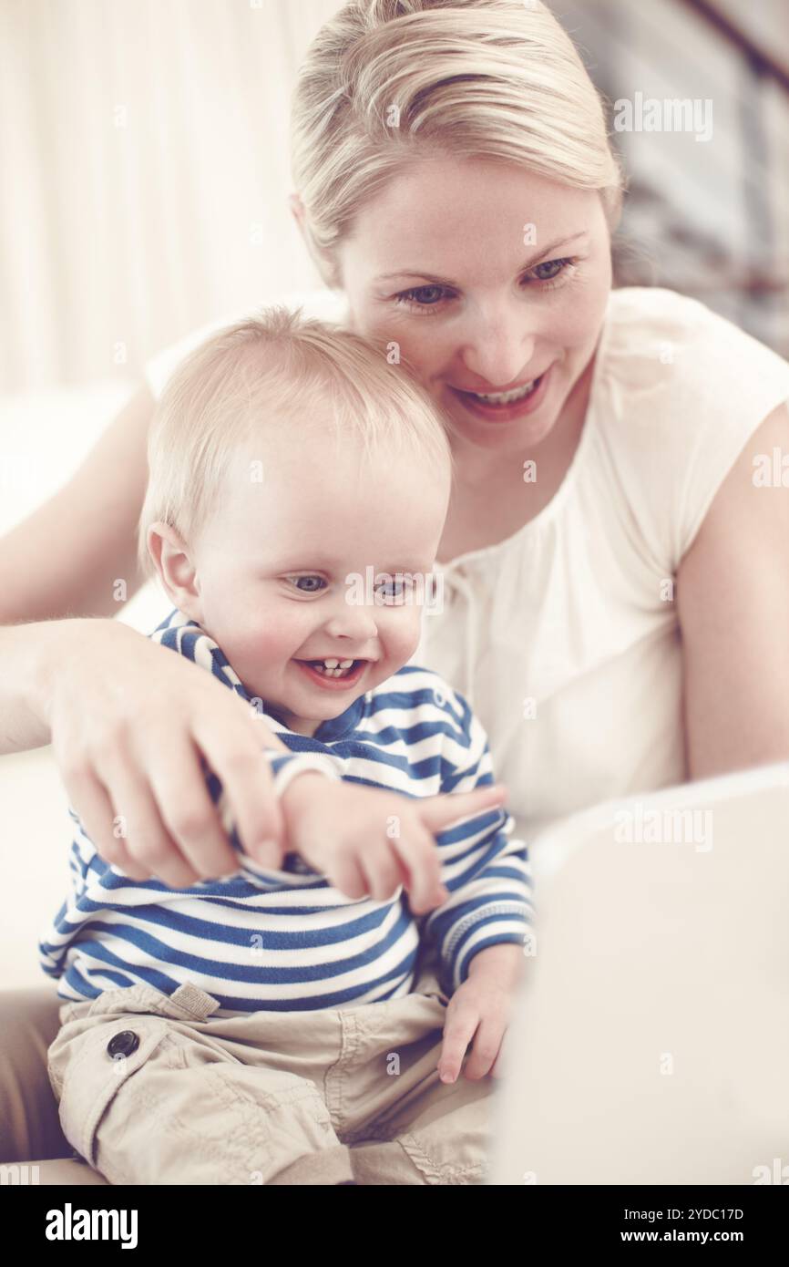 Woman, baby and happy on sofa with tech, entertainment or child ...