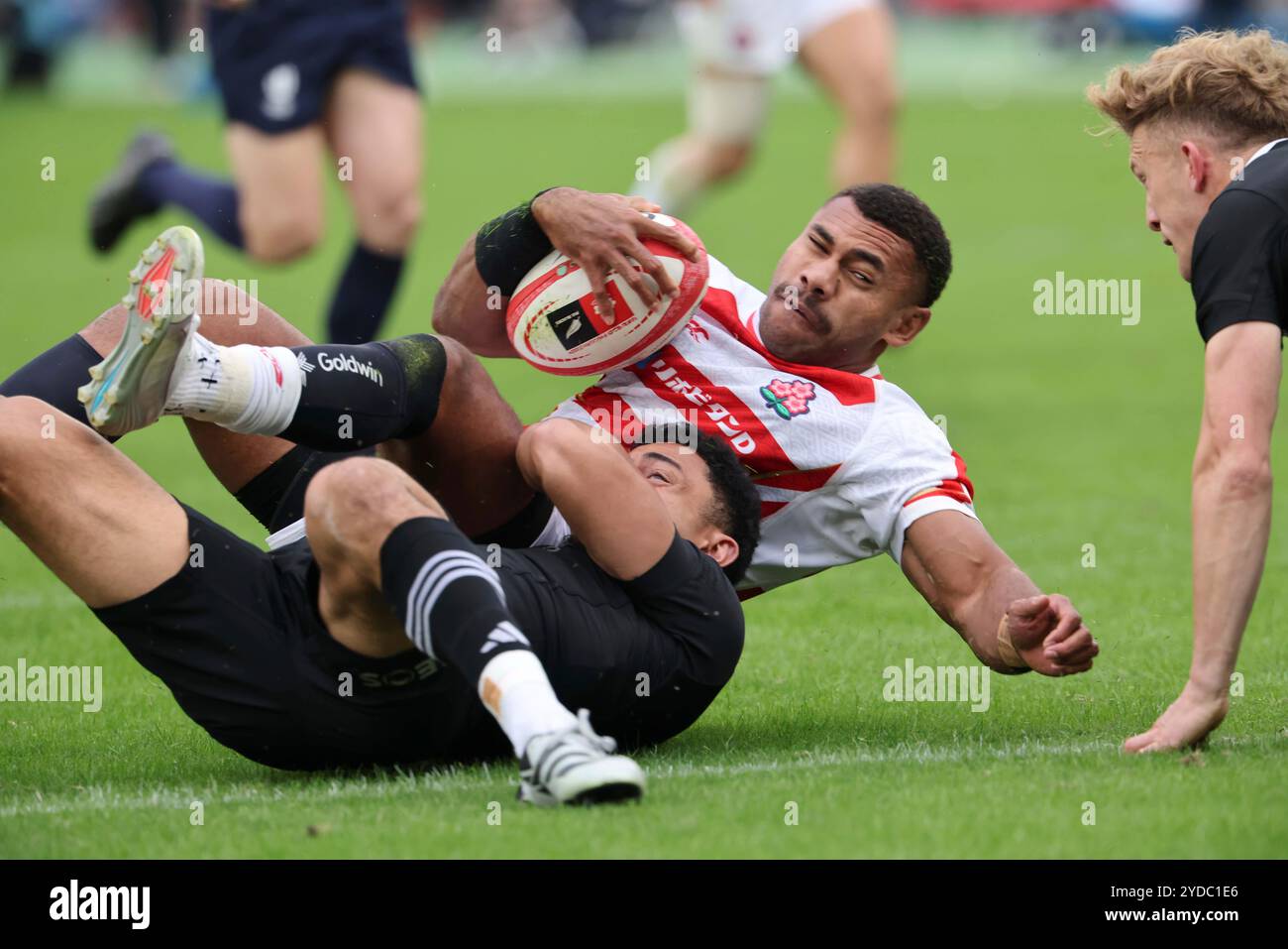 Jone NAIKABULA of Japan (top) scores with a try in the first half of ...
