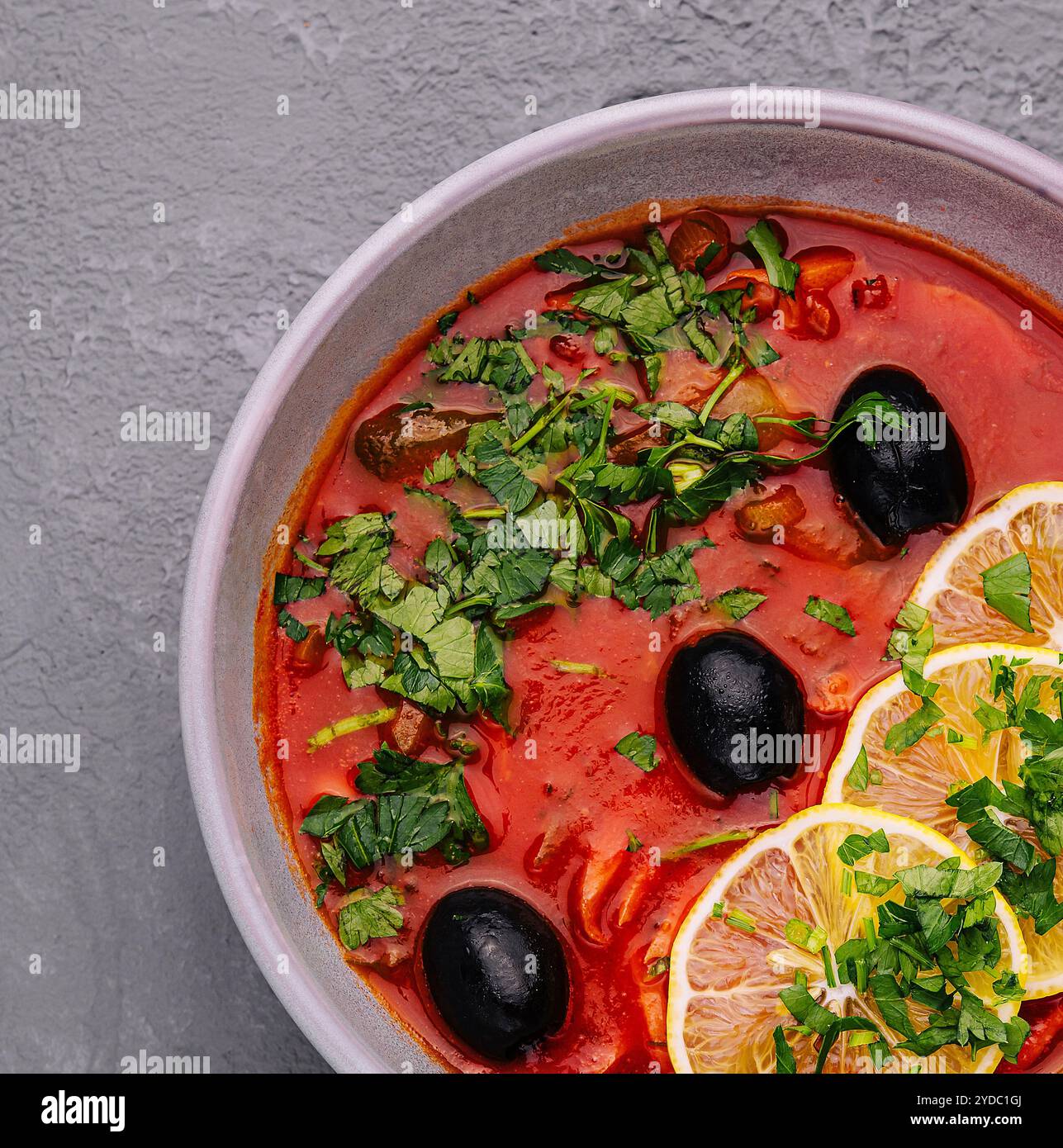 red soup Solyanka, with sausage, olives and lemon Stock Photo - Alamy