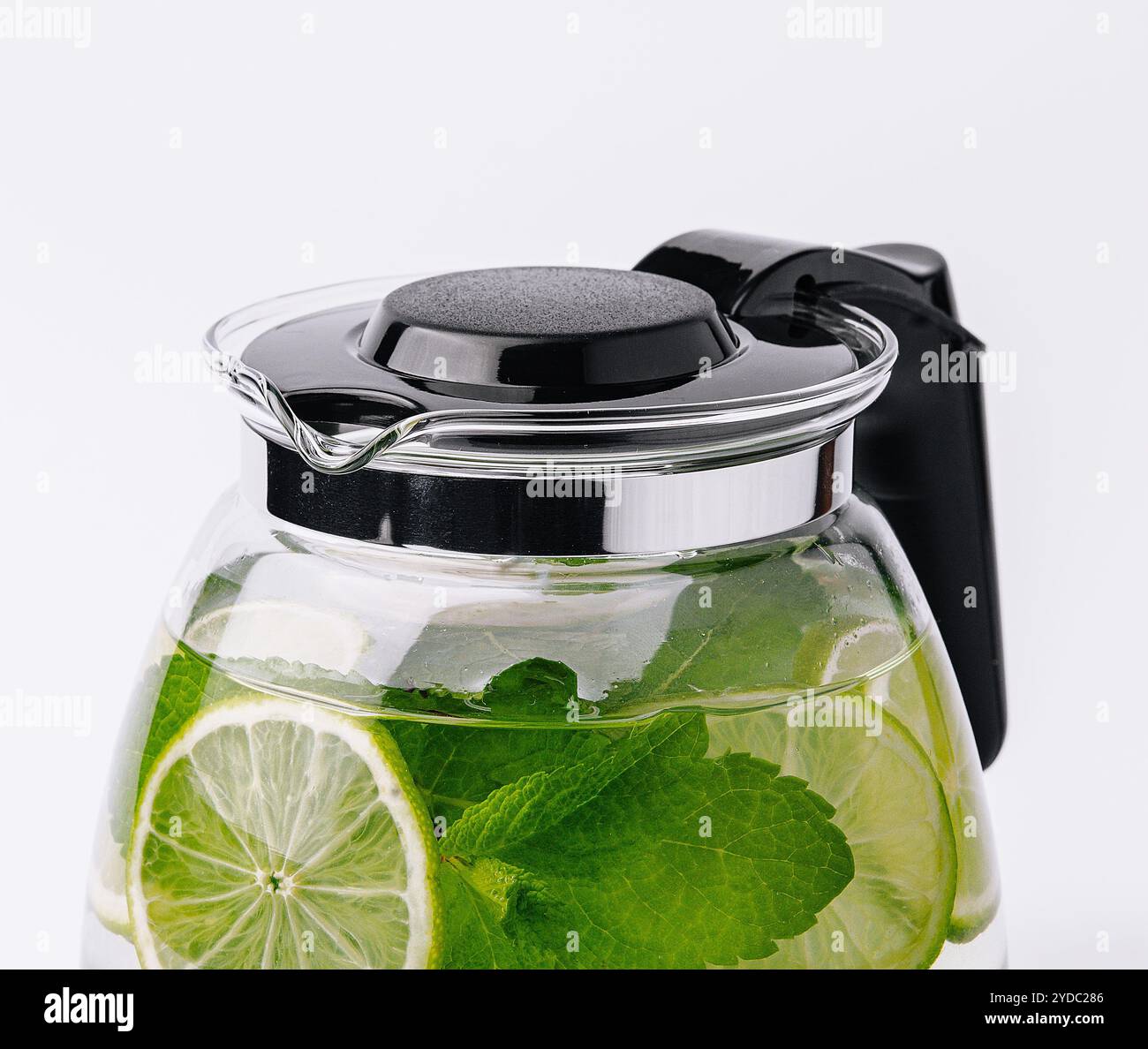 Fruit water with lime and mint in glass pitcher Stock Photo - Alamy