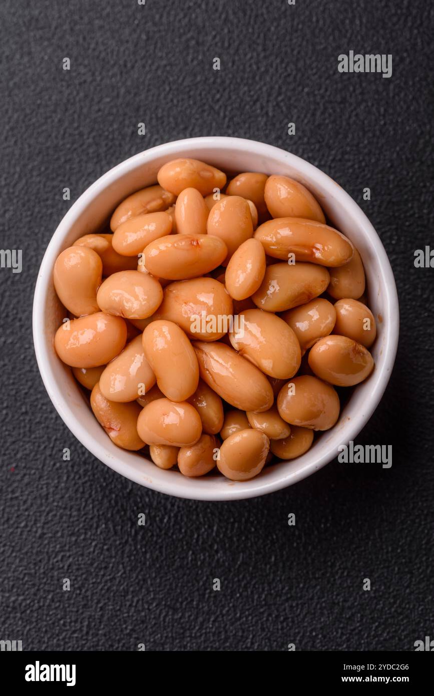 Delicious nutritious canned beans in tomato, with salt and spices as a ...