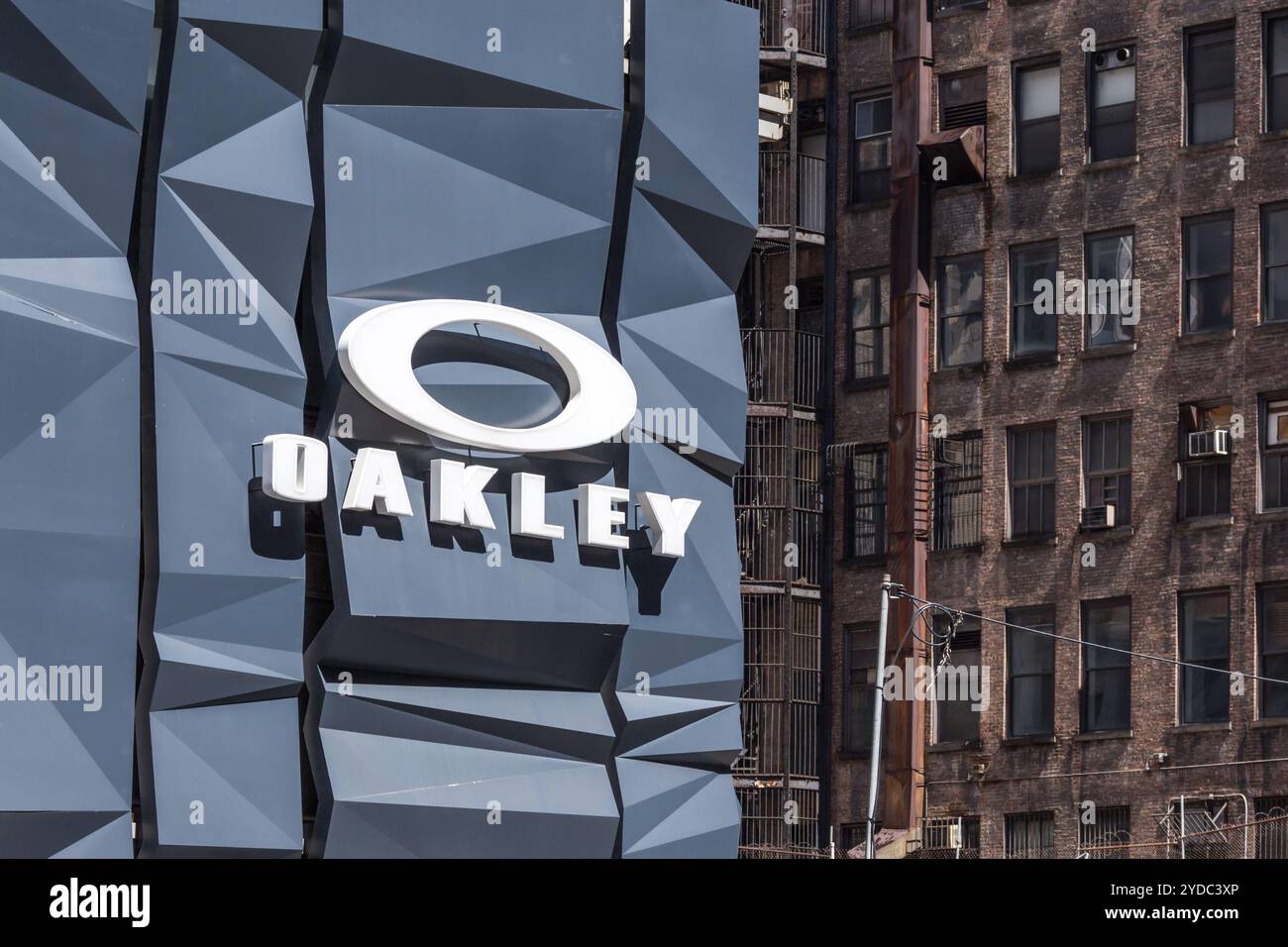 NEW YORK, USA - MAY 15, 2019: Oakley logo Sign on wall above store in ...