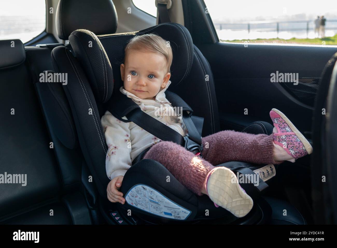 Baby in a car seat enjoying a car ride. Concept of travelling safely ...