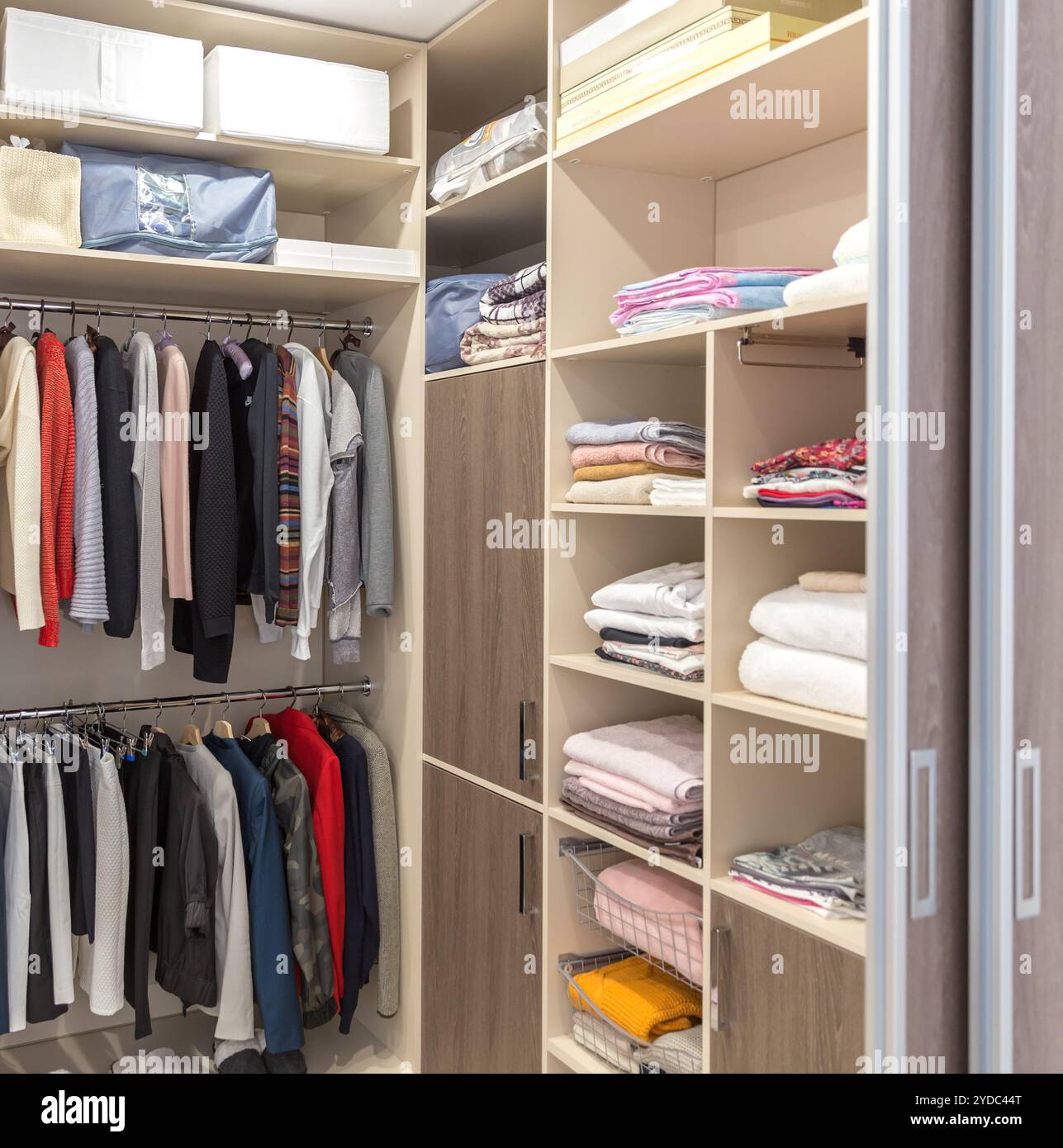 Big wardrobe with different clothes for dressing room Stock Photo - Alamy