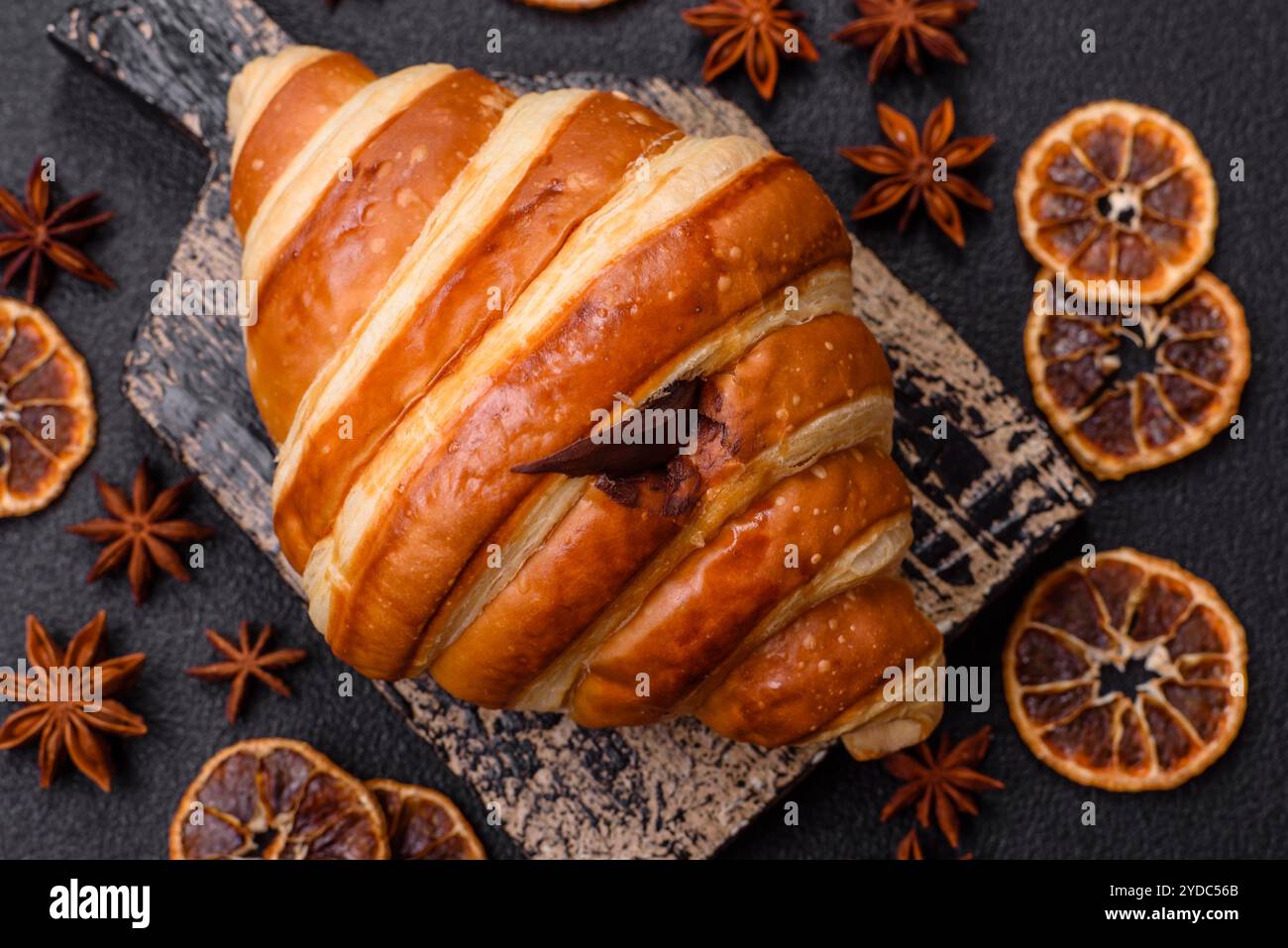 Delicious crispy sweet croissant cornet with chocolate on a dark ...