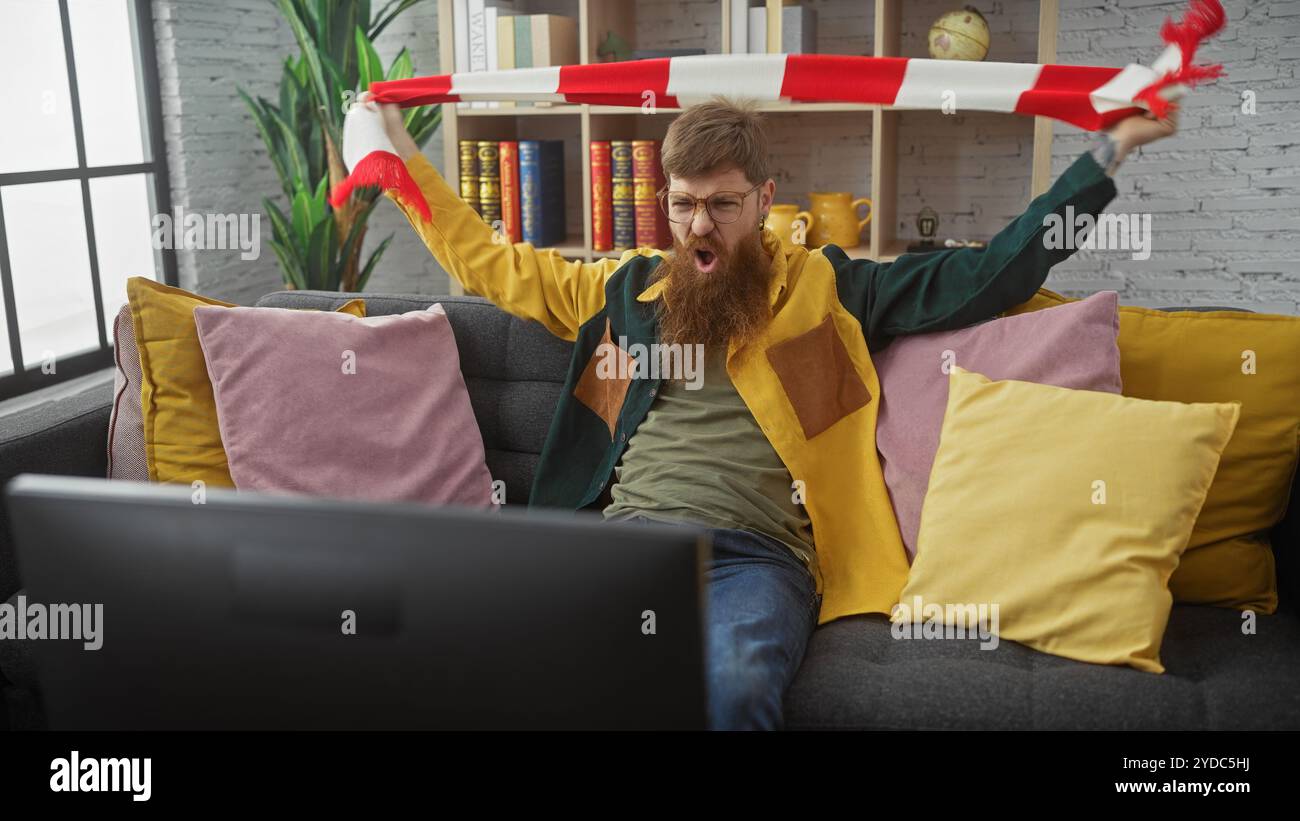 Excited bearded man celebrating victory at home with a laptop and ...